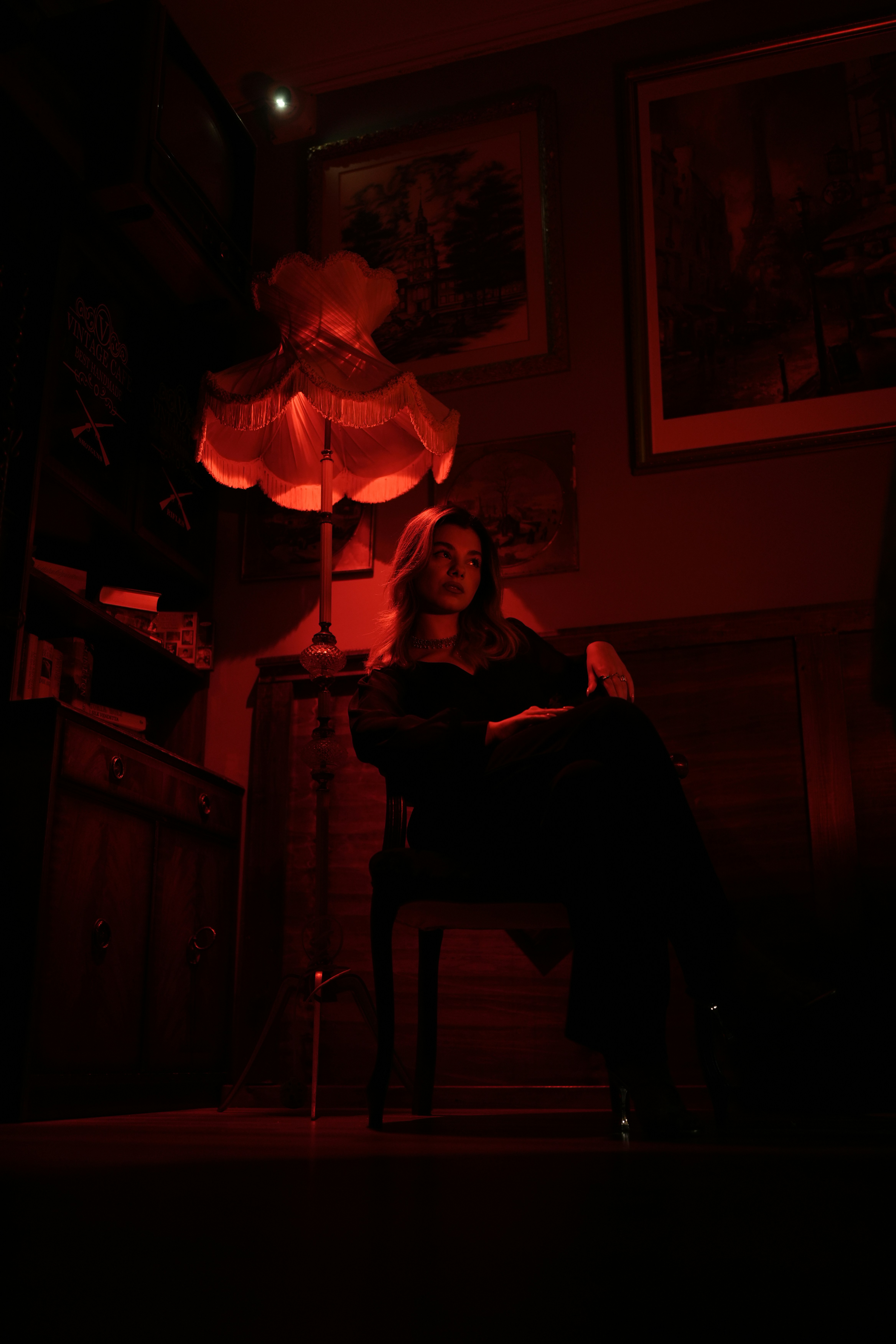 Red-Hued Reverie: A Quiet Portrait in the Dim Lounge