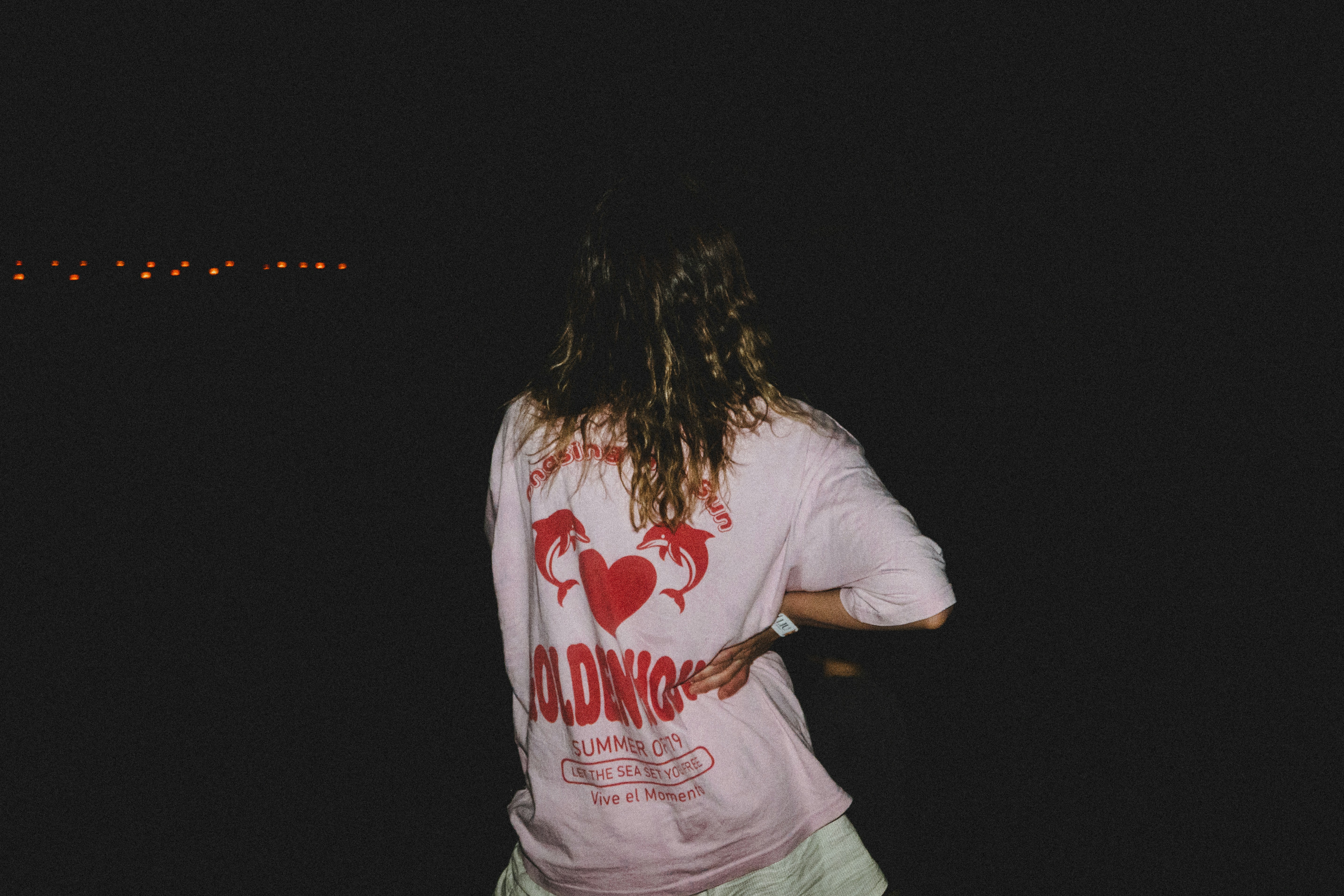 Midnight Run: Back View of a Person in a Pink Shirt with Red Graphic