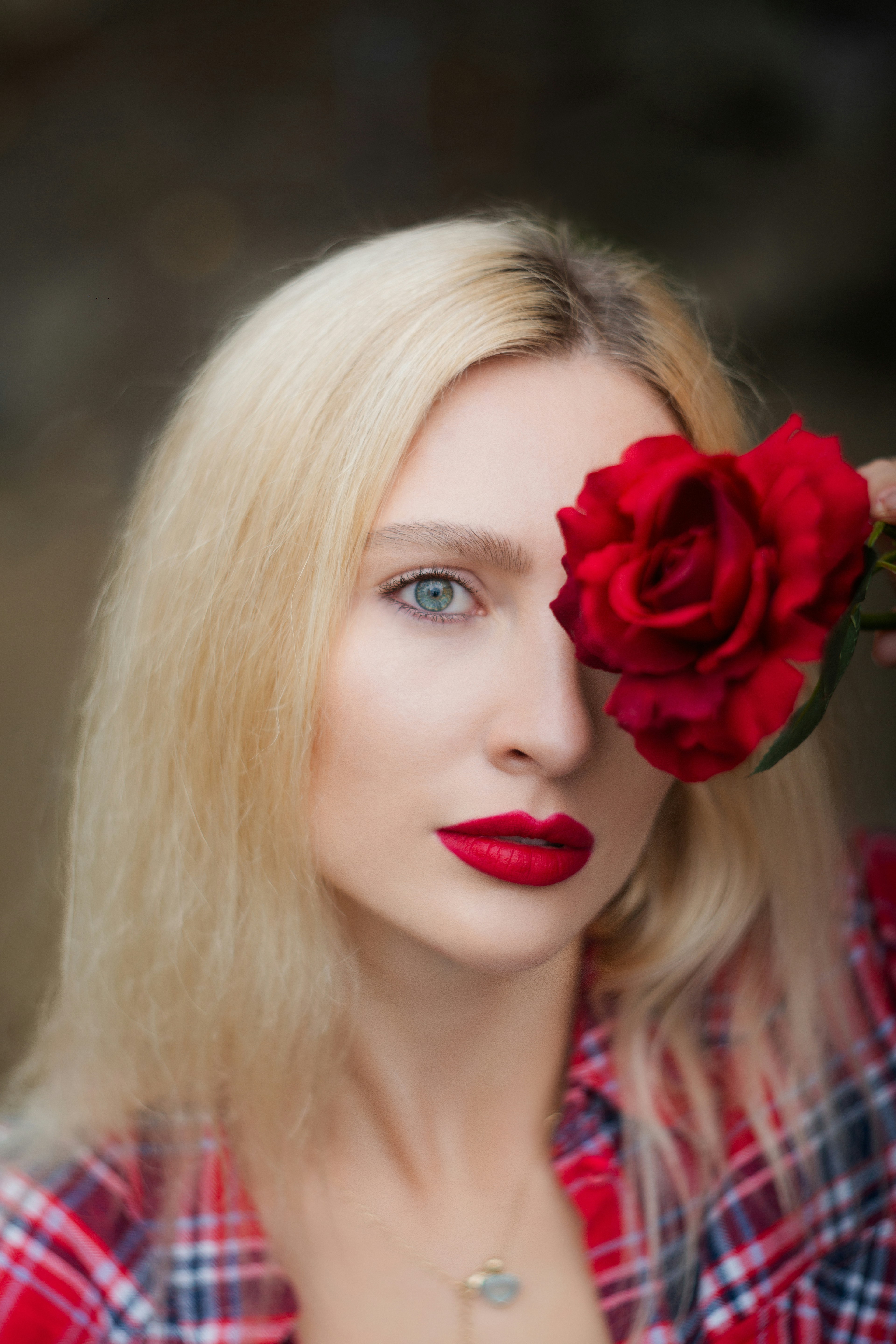 Scarlet Bloom: A Portrait Framed by a Velvet Rose