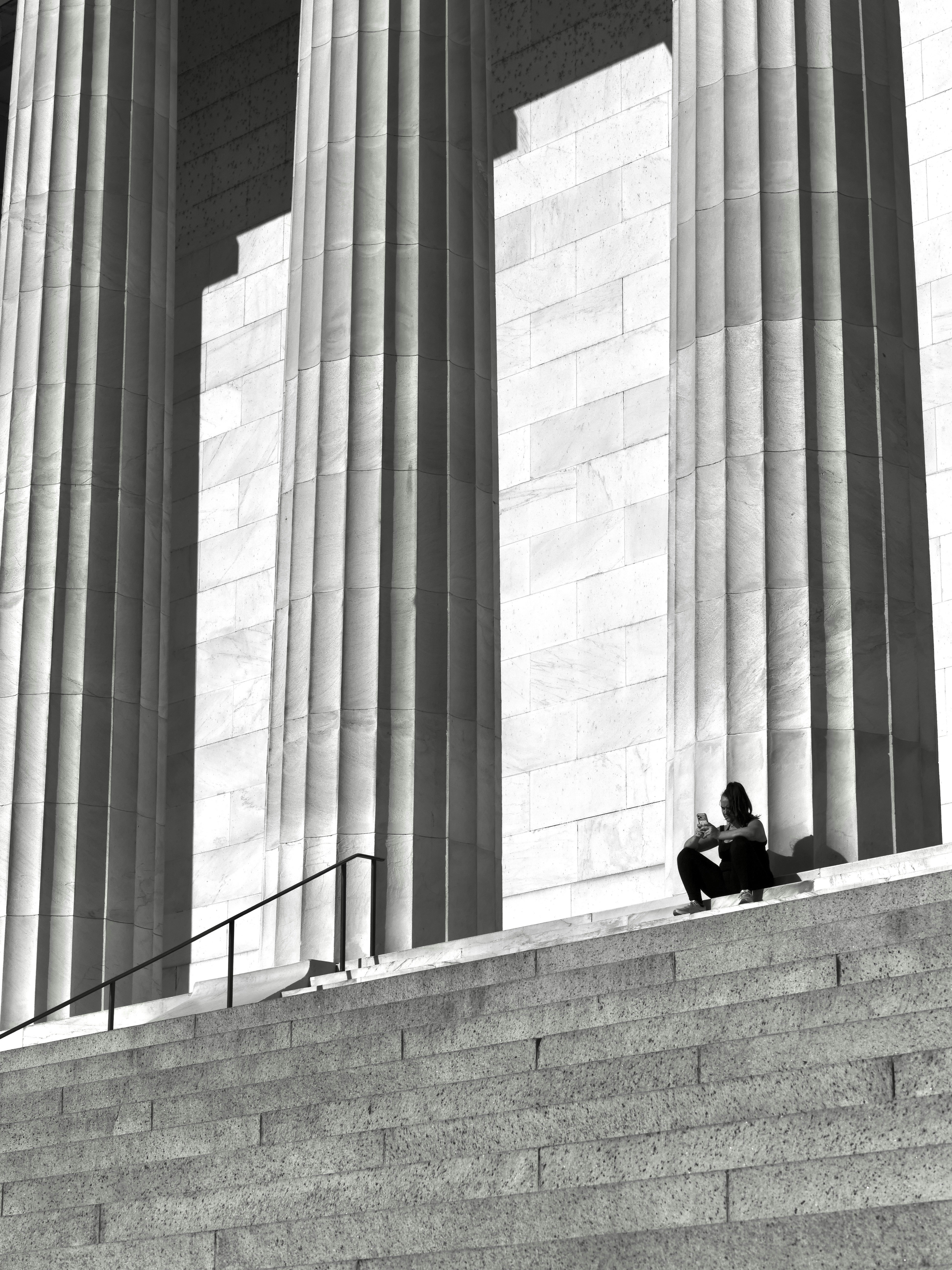 Silhouette on the Steps Beneath Monumental Columns
