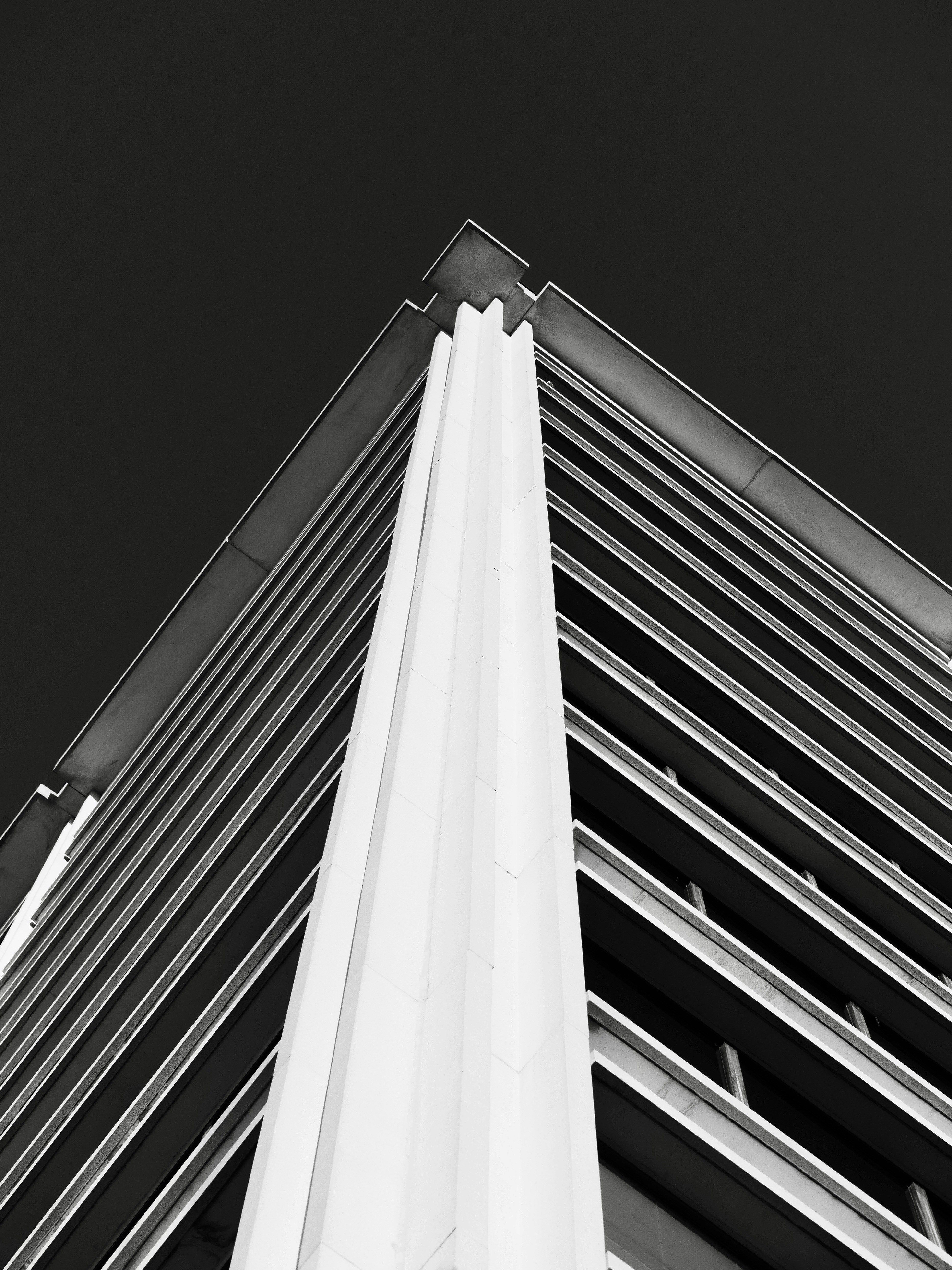 Architectural Ascent: A White Spire Piercing the Dark Sky