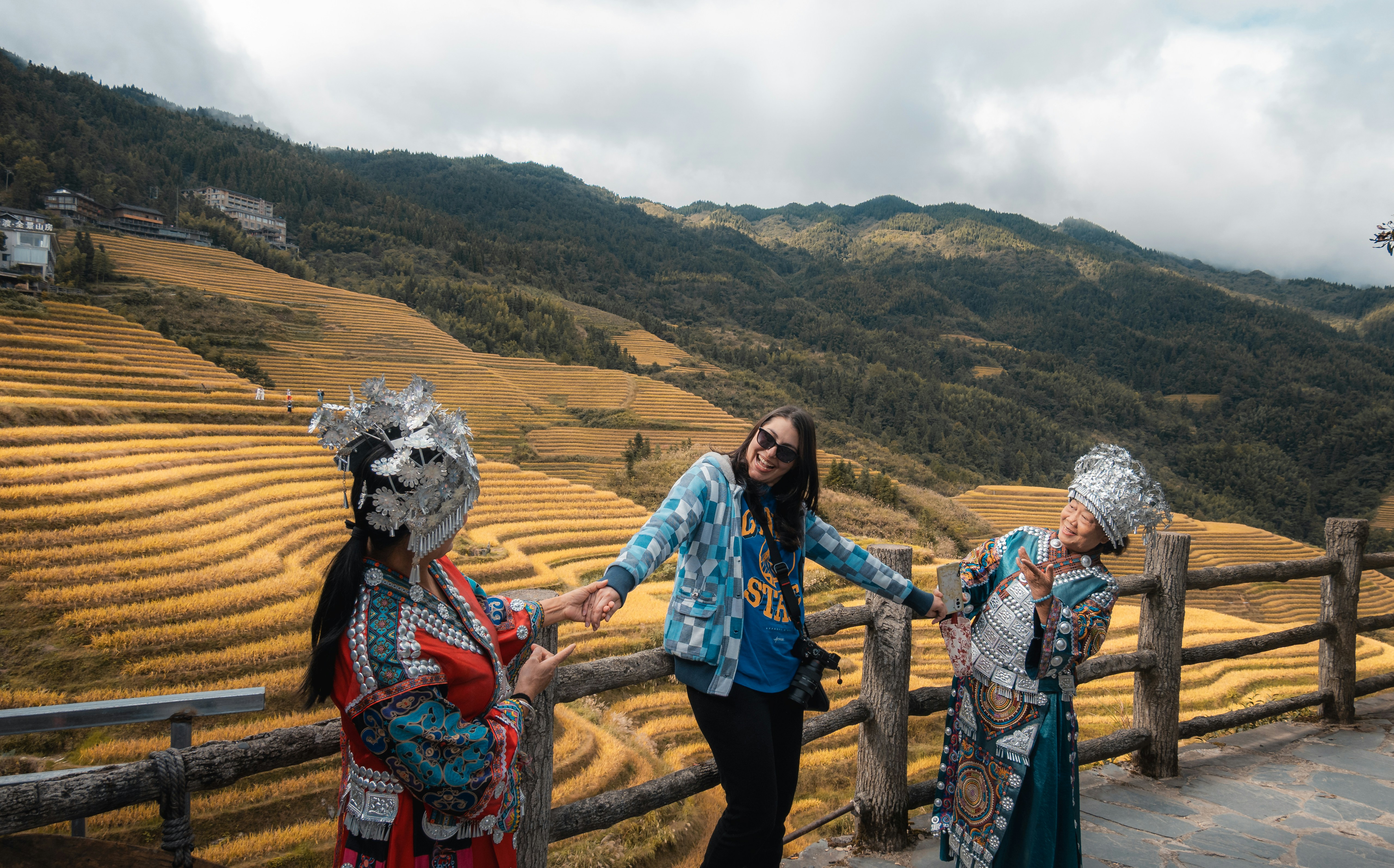 Three Guides at a Terraced Ridge: A Portrait Amid Golden Fields