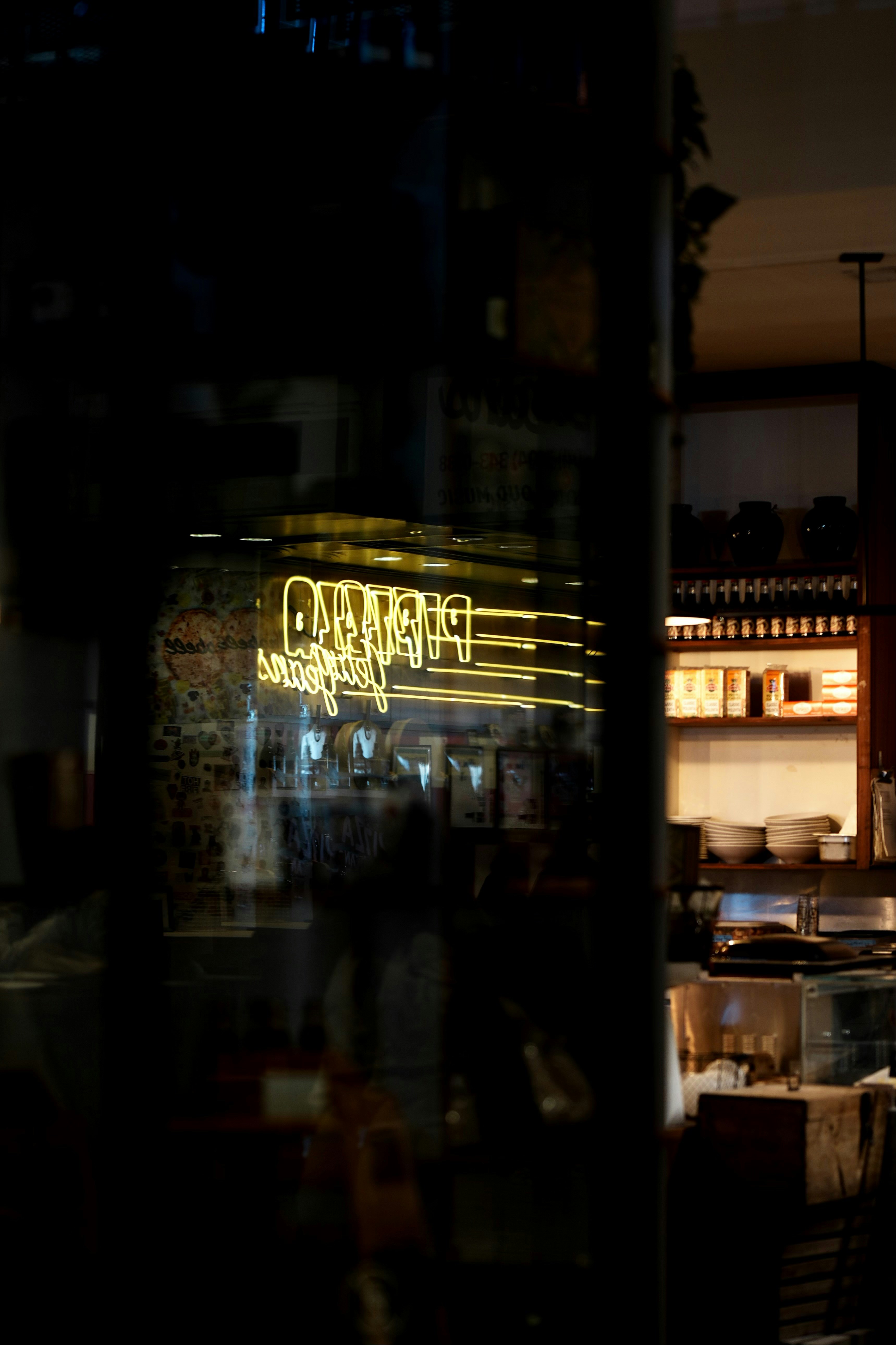Neon Sign Reflections Across a Midnight Café Window