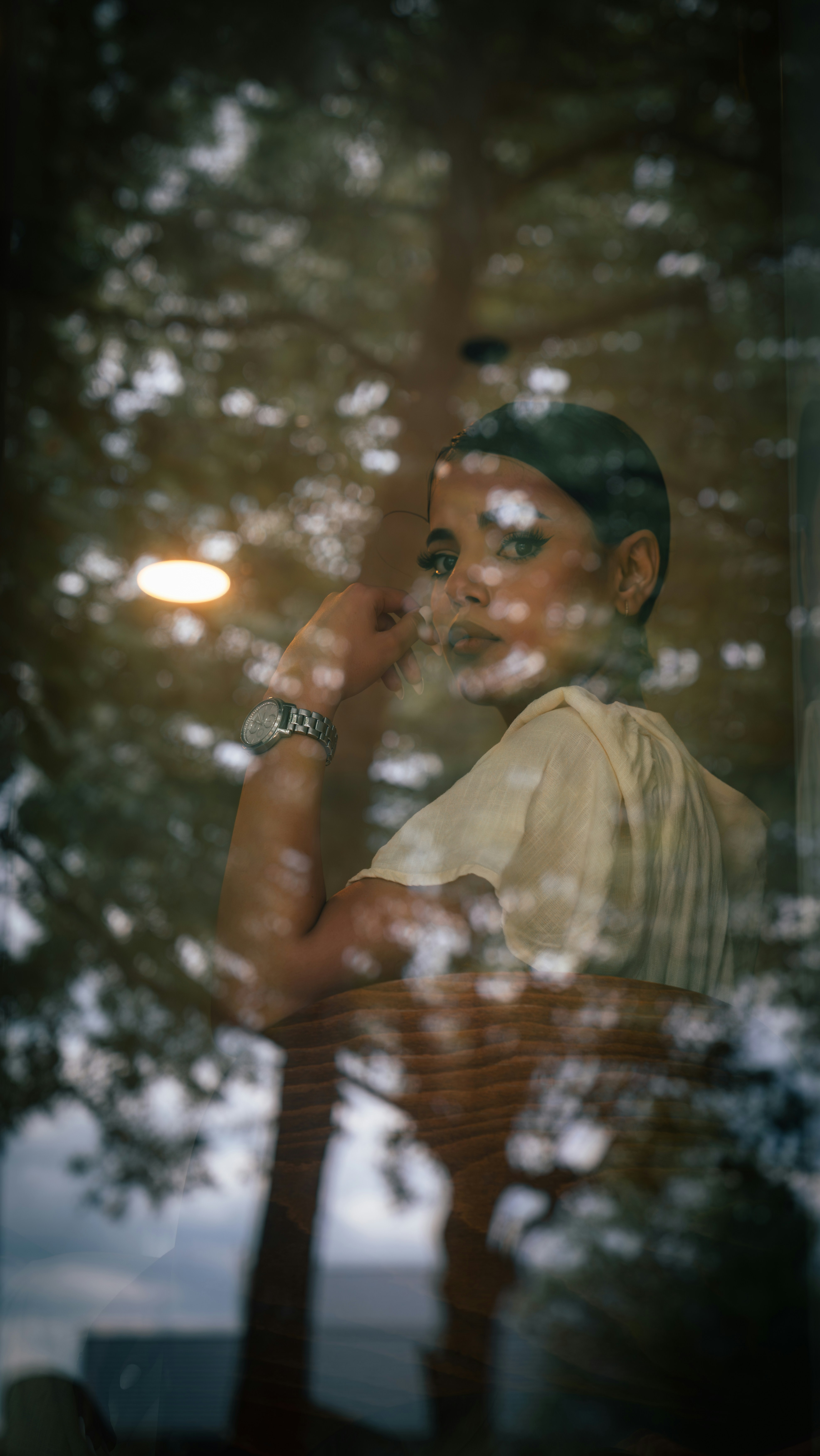 Reflected Gaze: A Pensive Portrait Through Glass
