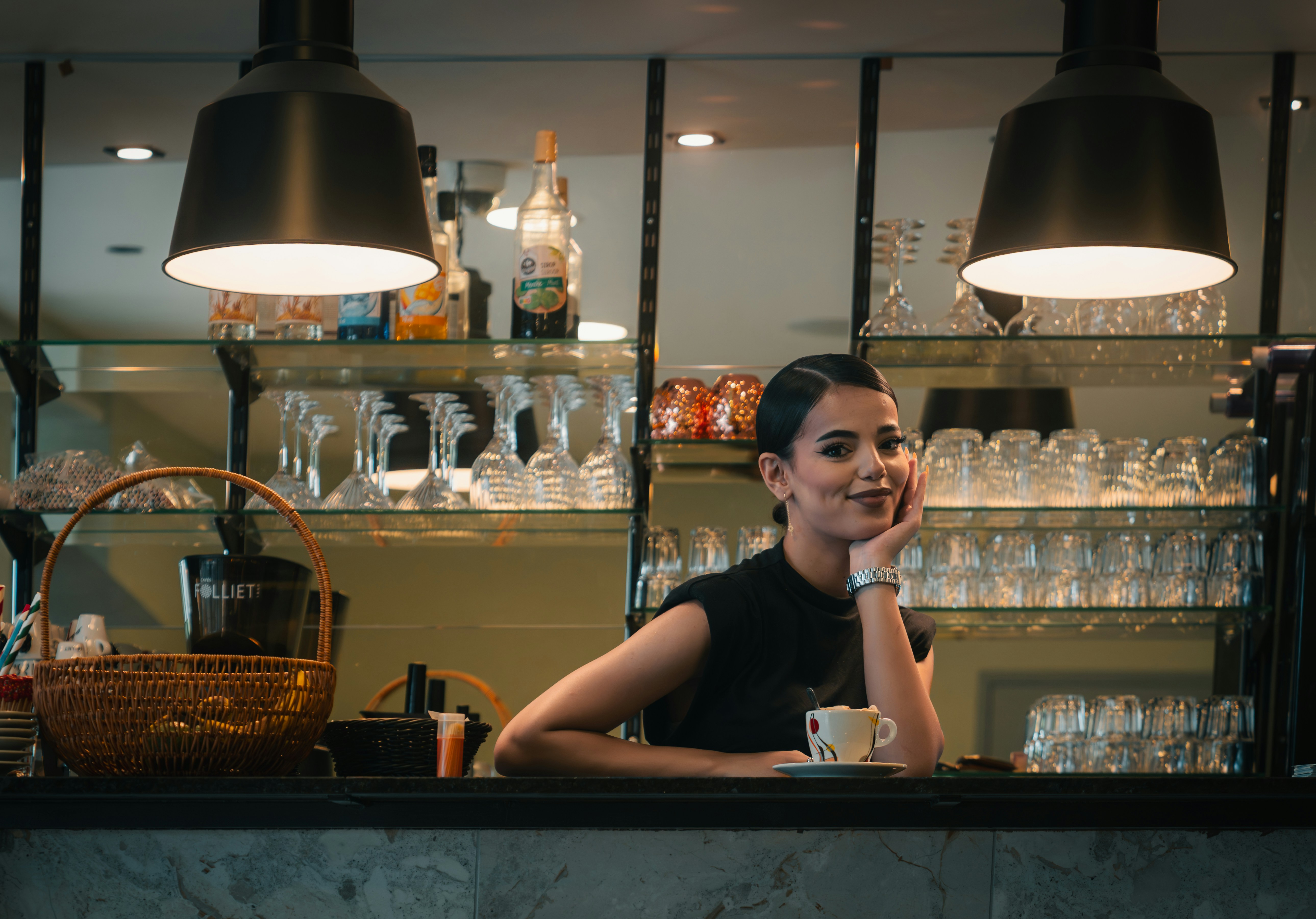 Barista with a Moment: Quiet Gaze Over Espresso Lights