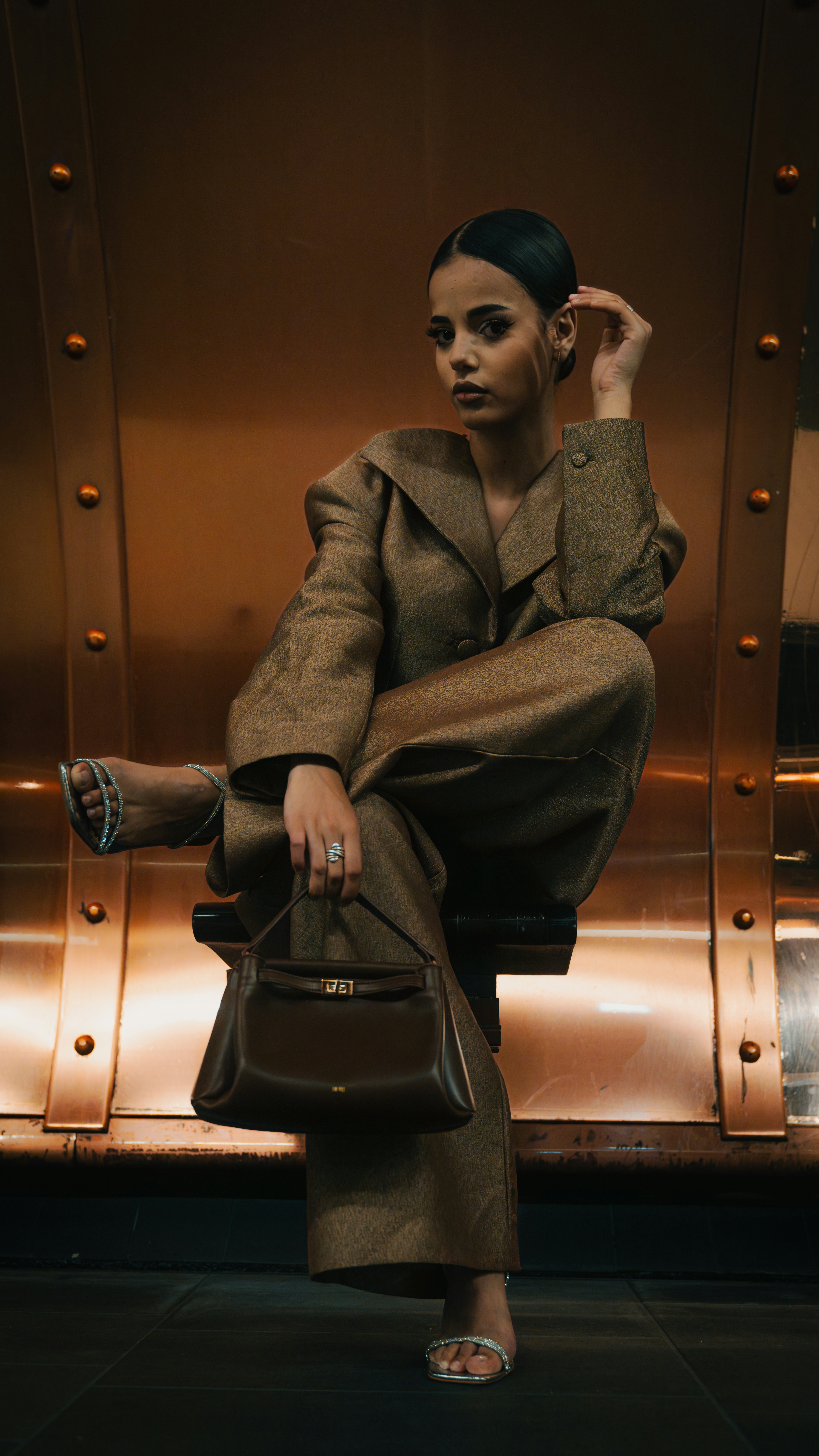 Copper-lit Confident: A Velvet Suit Portrait in a Metallic Booth