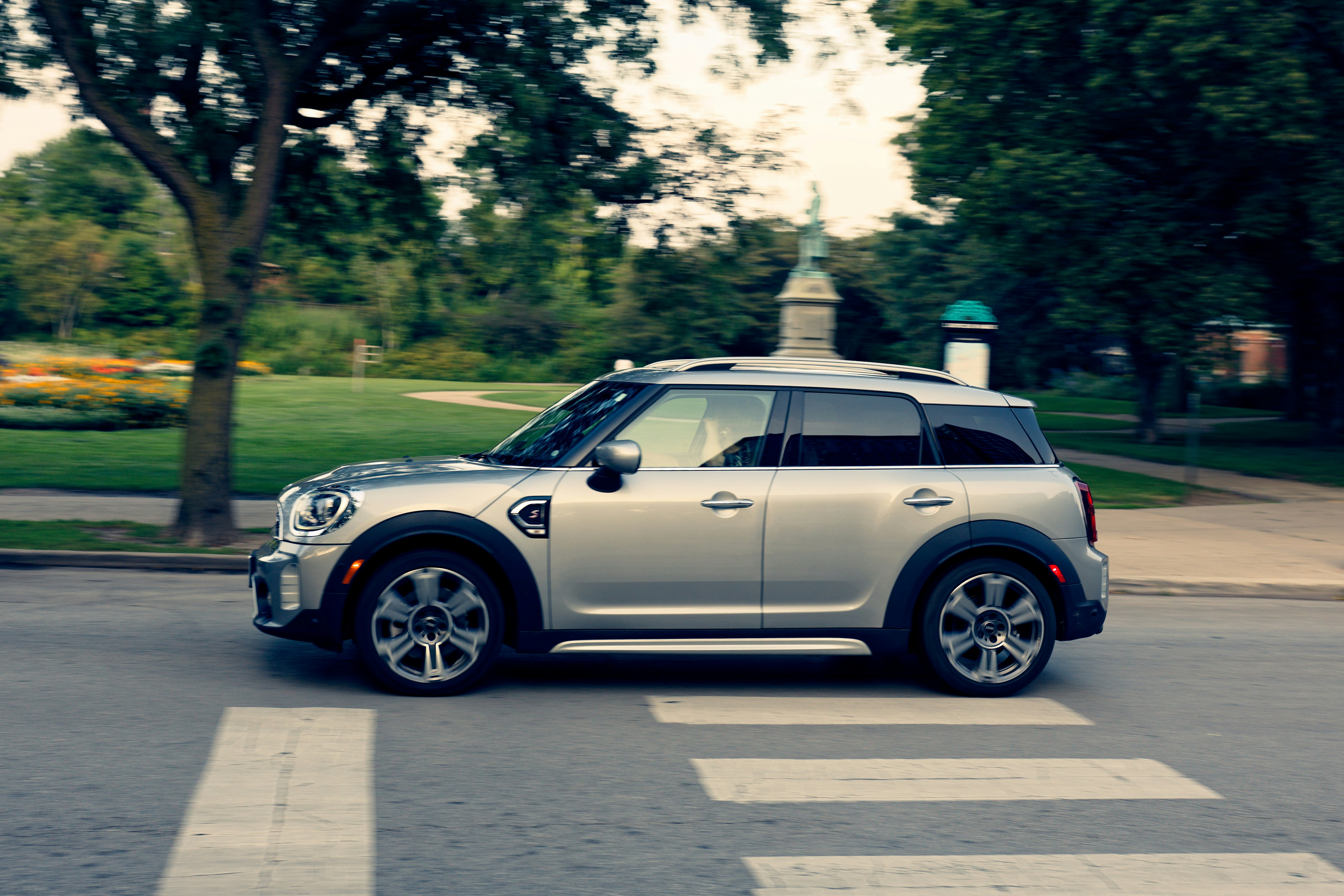 Silver crossover parked mid-street, cinematic bloom across the frame