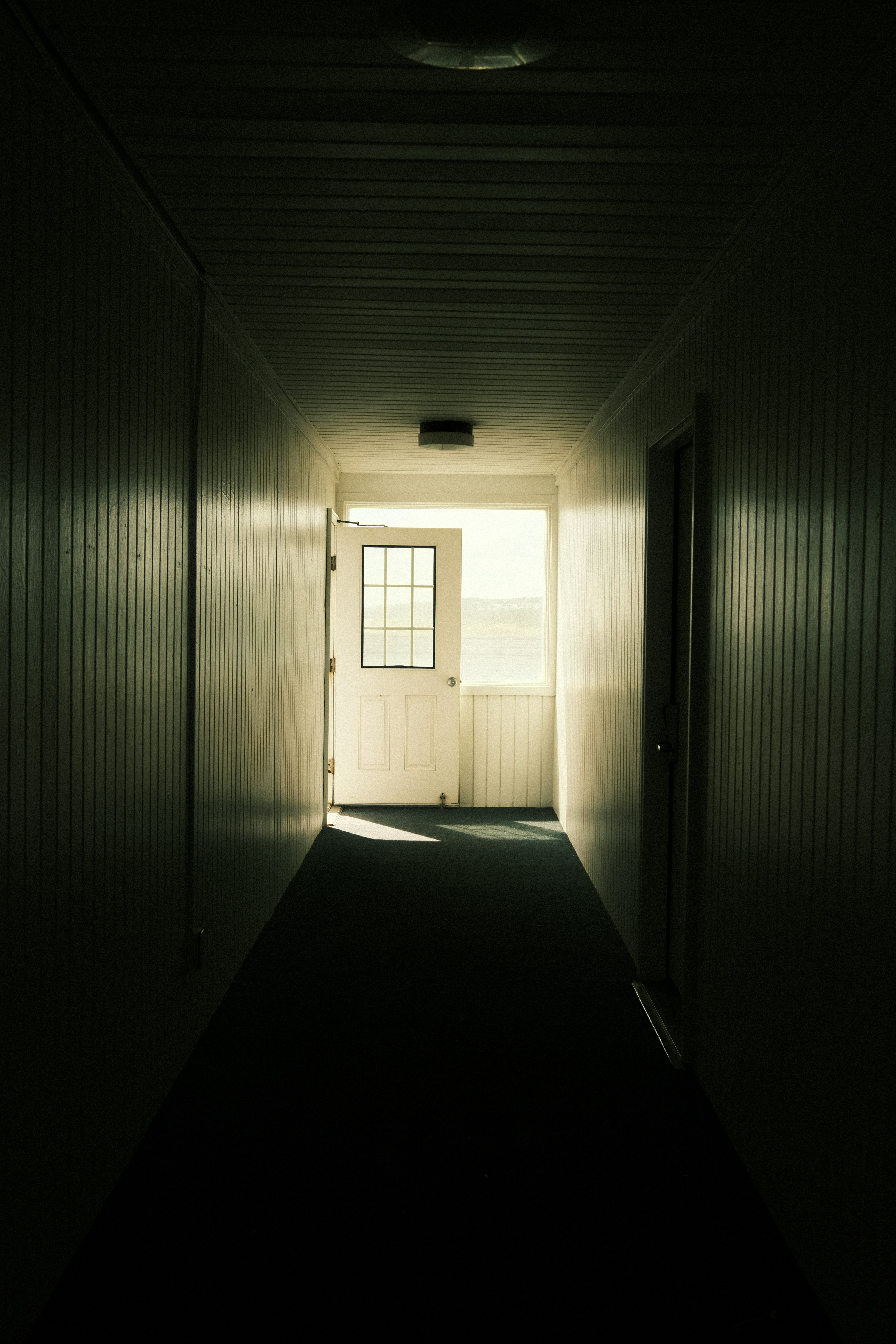 Light at the End: A Quiet Hallway Opens onto a Distant Window