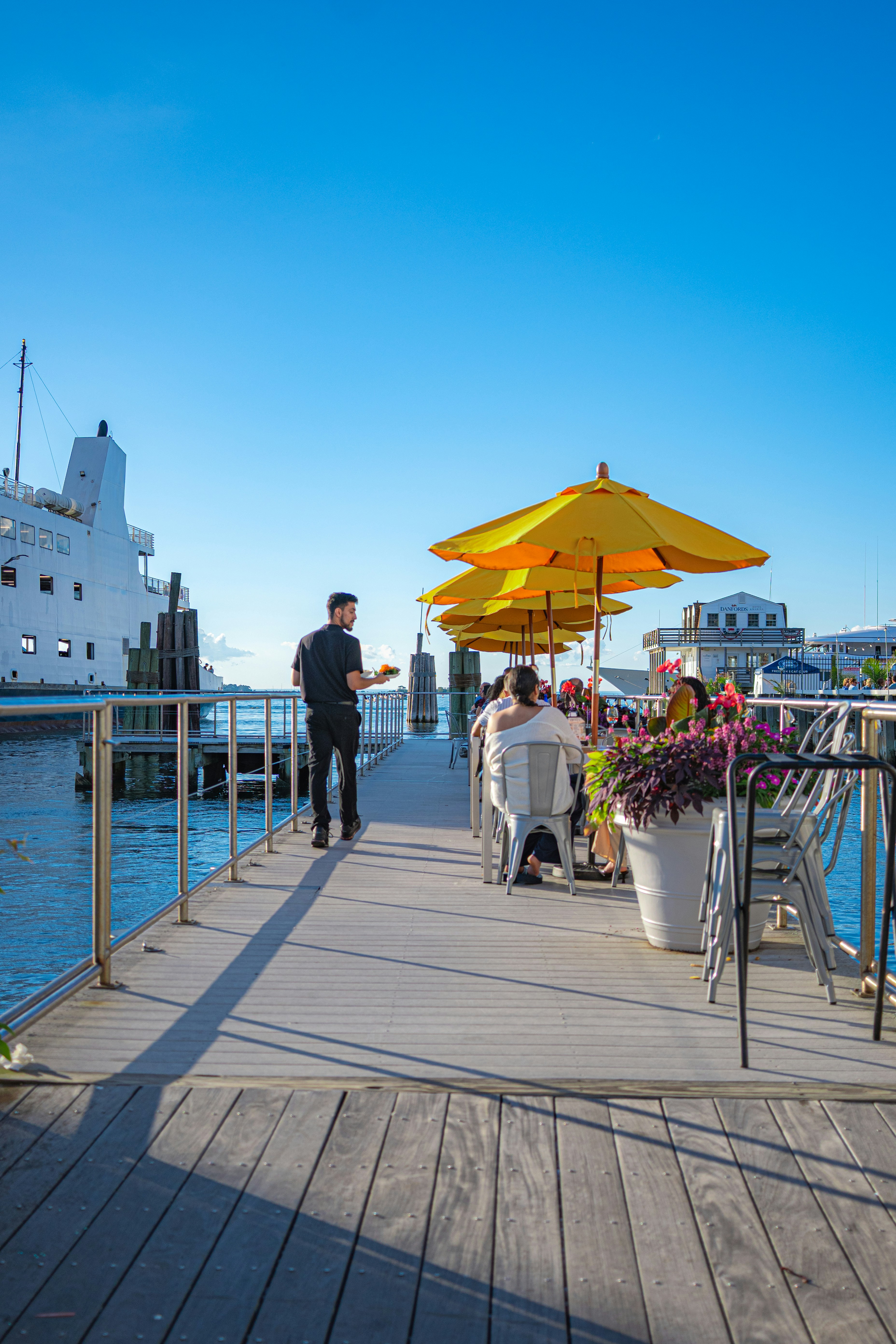 Sunlit Terrace by the Harbor: Yellow Parasols and Quiet Waves