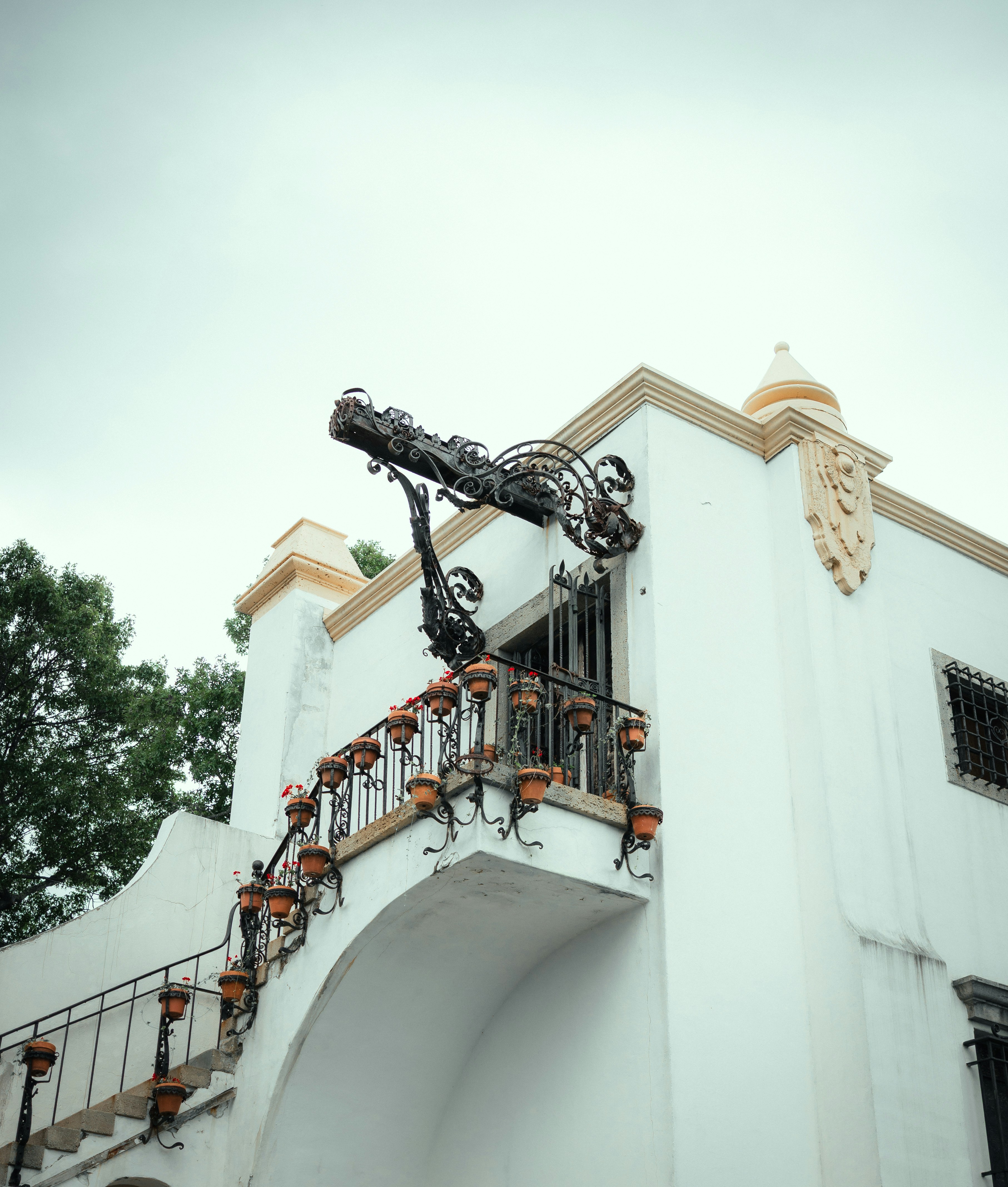 Ornate Balcony Cascade on a Sunlit White Facade
