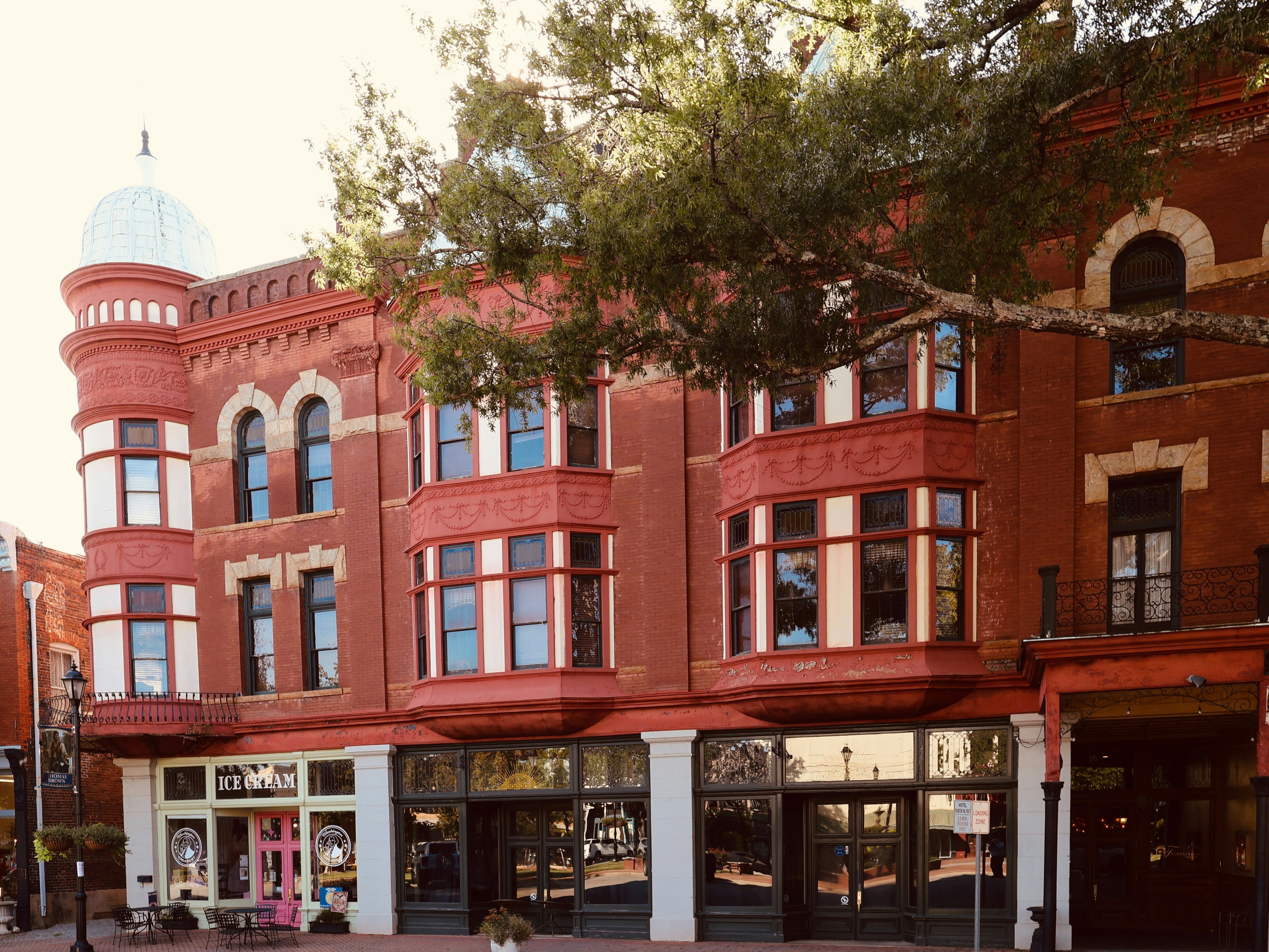 Red-Brick Corner: A Historic Facade Framed by Shaded Canopy