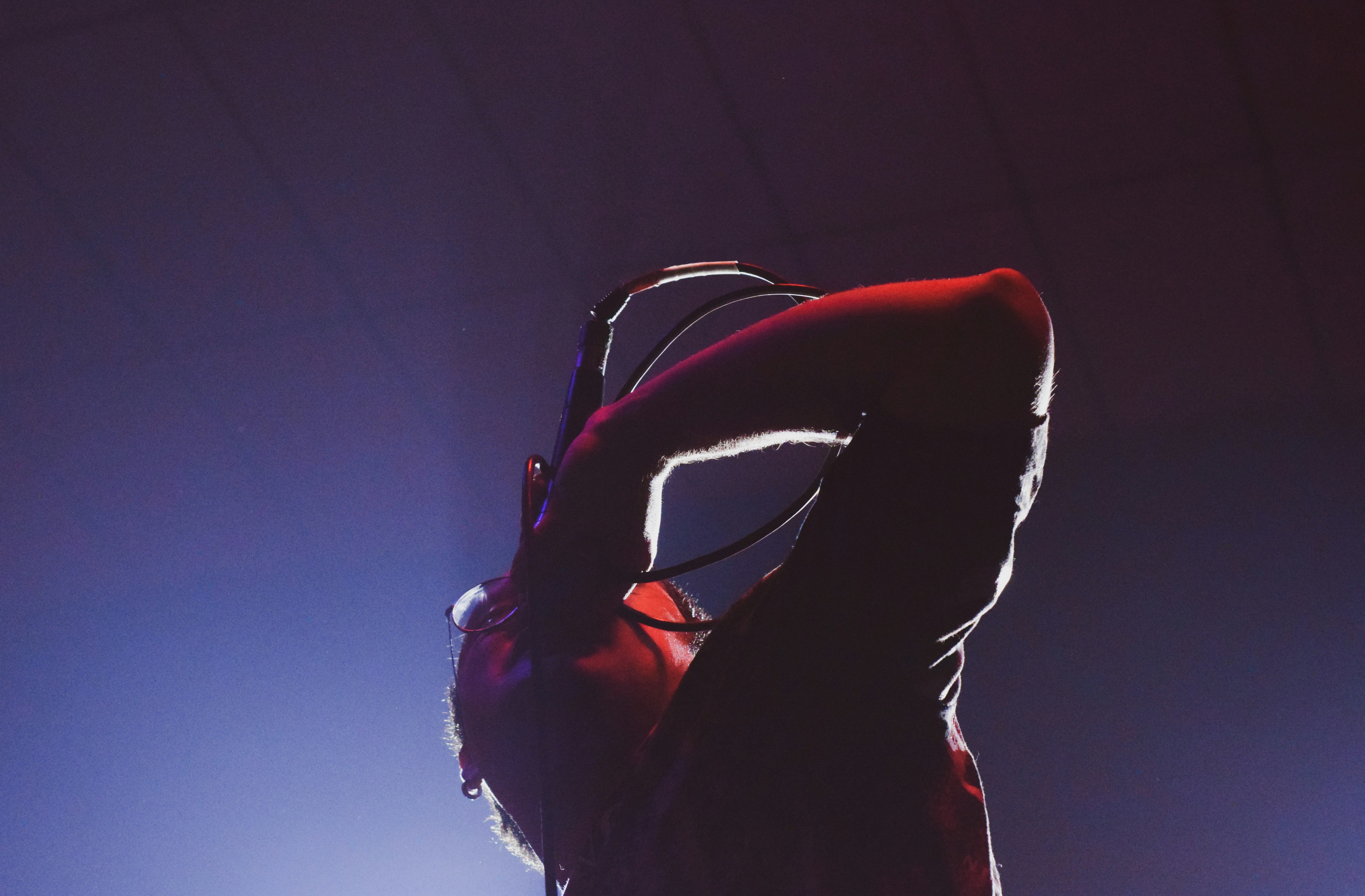 Low-angle silhouette of a performer against stage lighting, capturing dramatic outlines and a sense of motion; the image emphasizes form over detail. This is a photograph, not a painting or illustration.