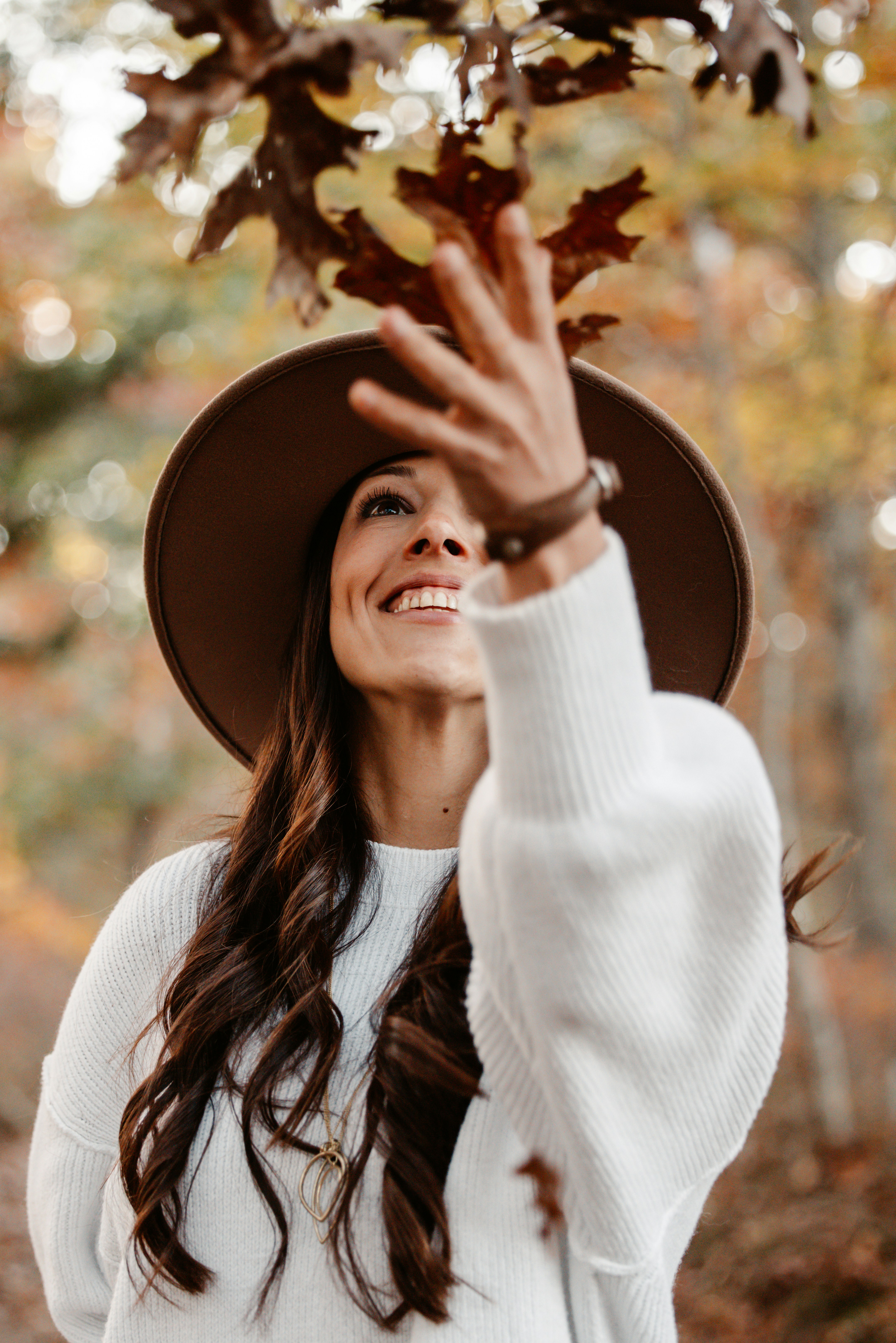 Autumn Leaves and a Warm Smile Under a Wide-Brim Note