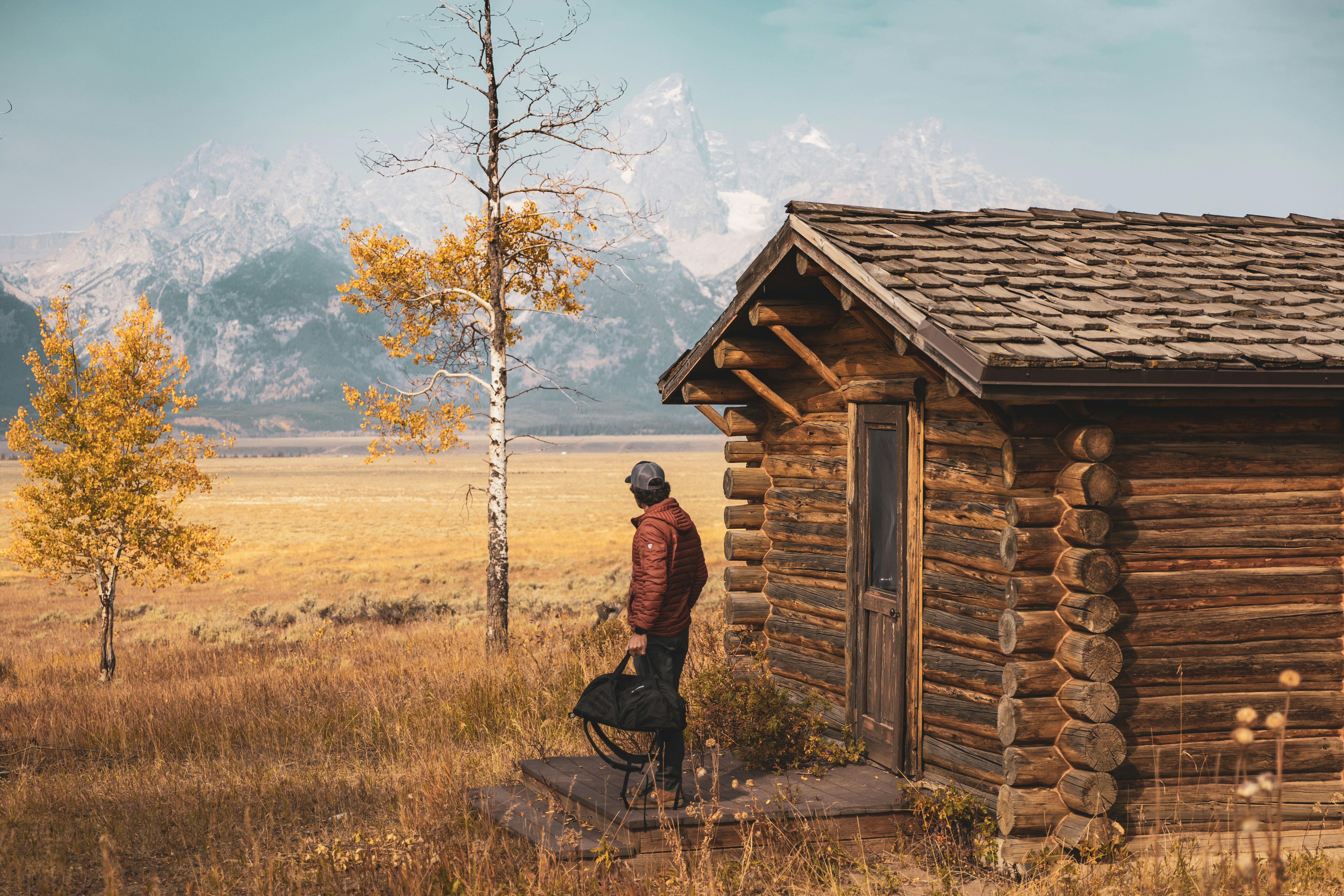 Lone Camper at Dusk by the Log Cabin