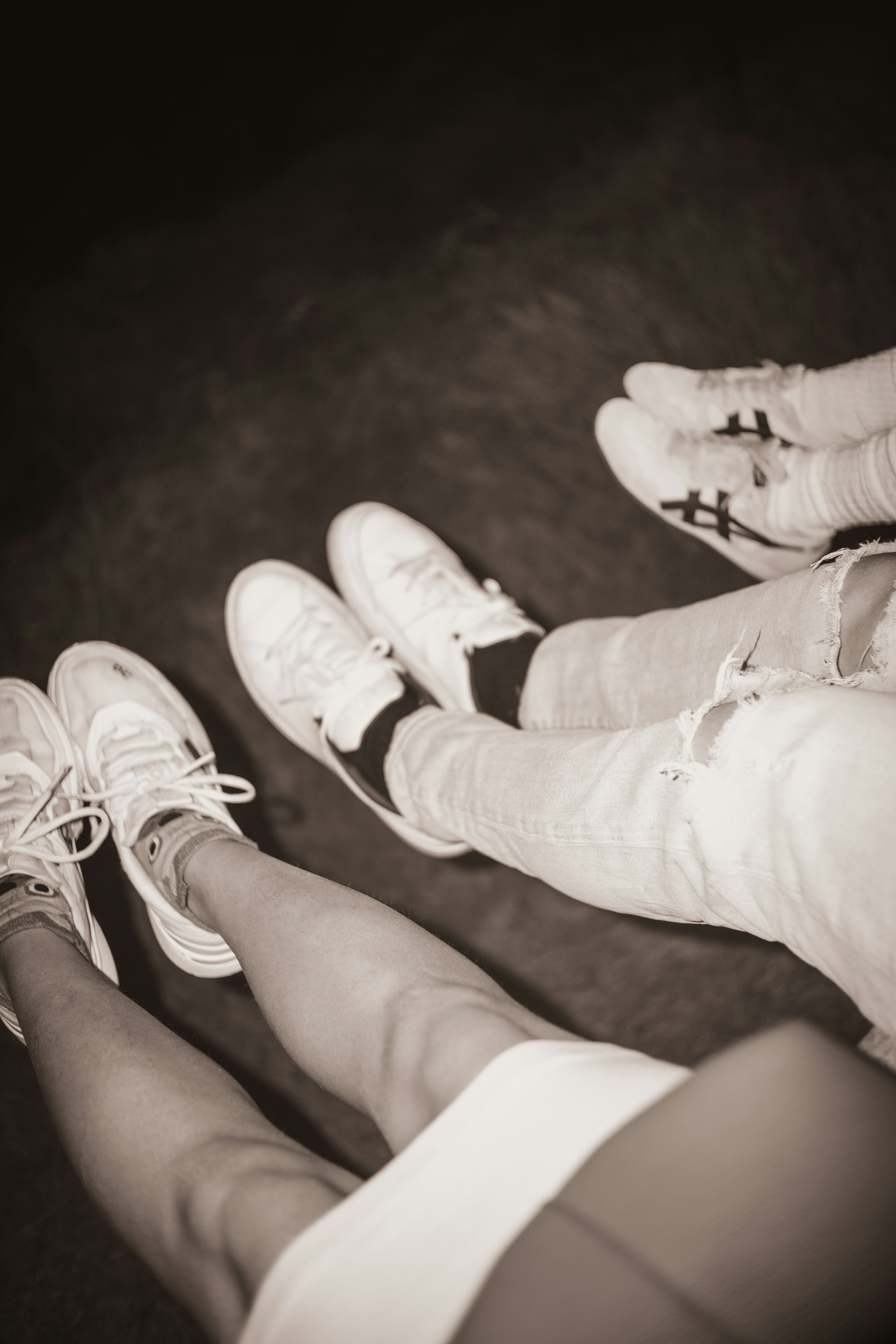 Feet in a Circle: Casual Shoes and Torn Denim