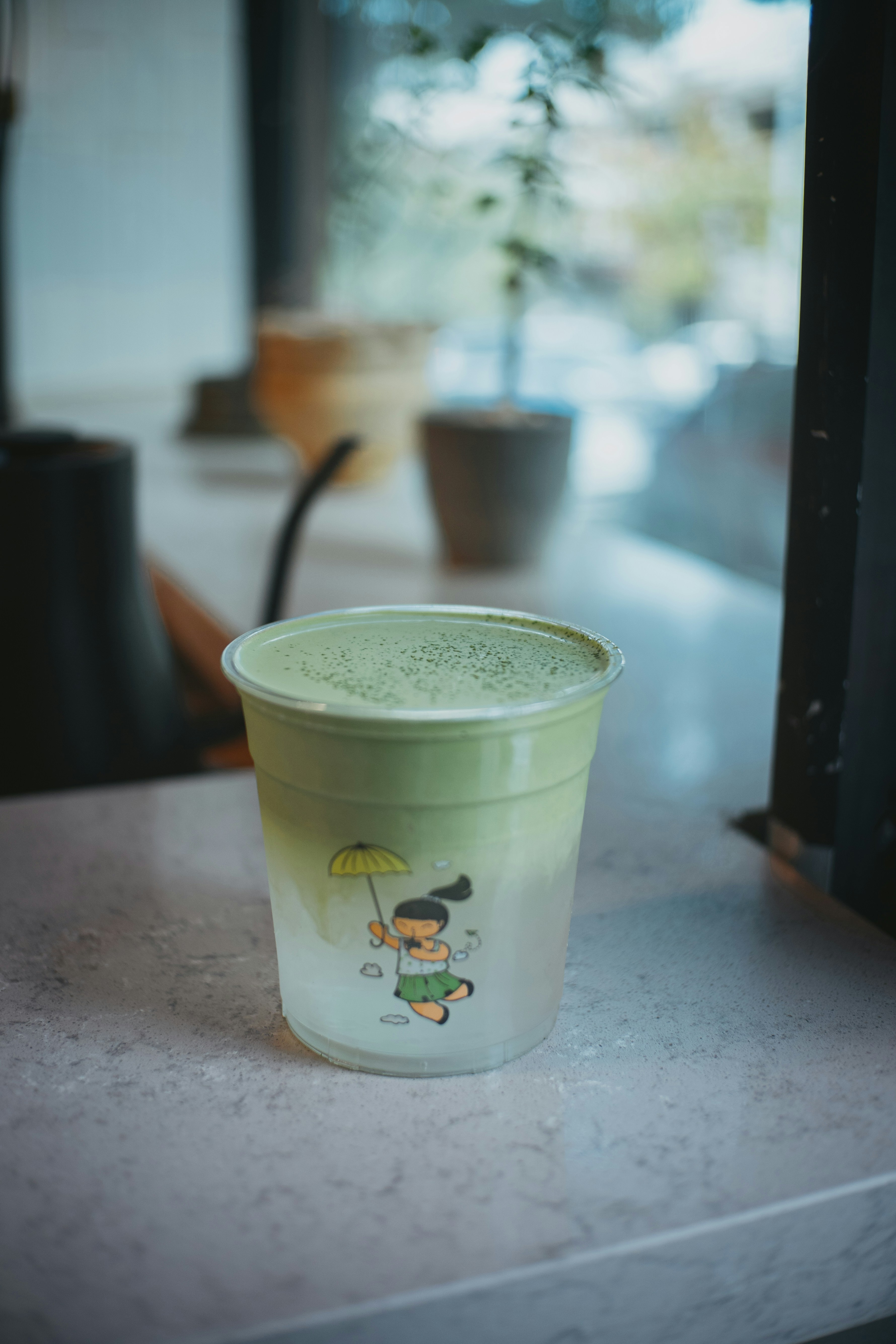 Green Matcha in a Whimsical Cup Finds Quiet Light