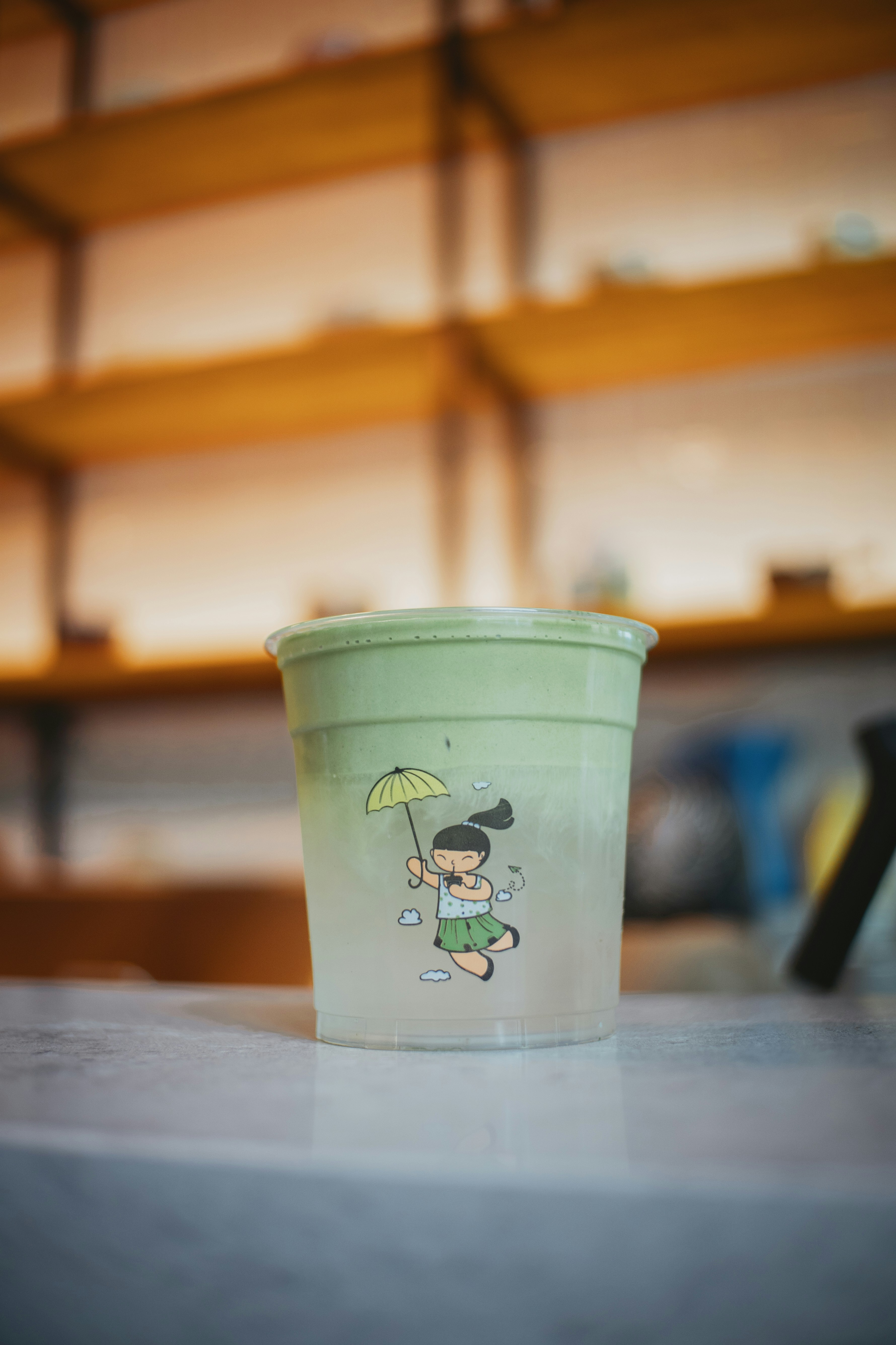 Green Cup in Focus: Calm Scene with Cartoon Illustration