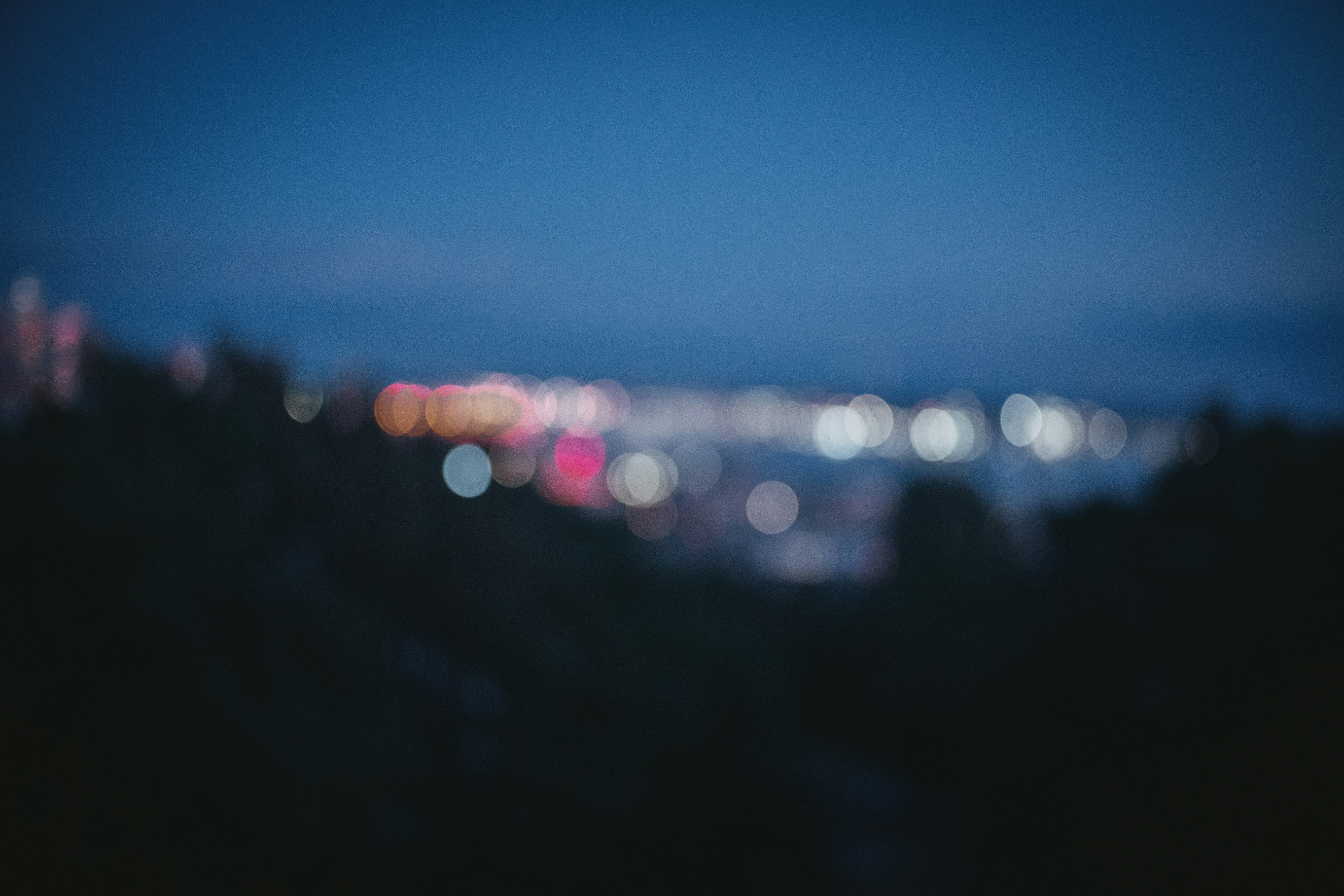 Evening Glimmer: City Lights Softly Blurred from a Quiet Overlook
