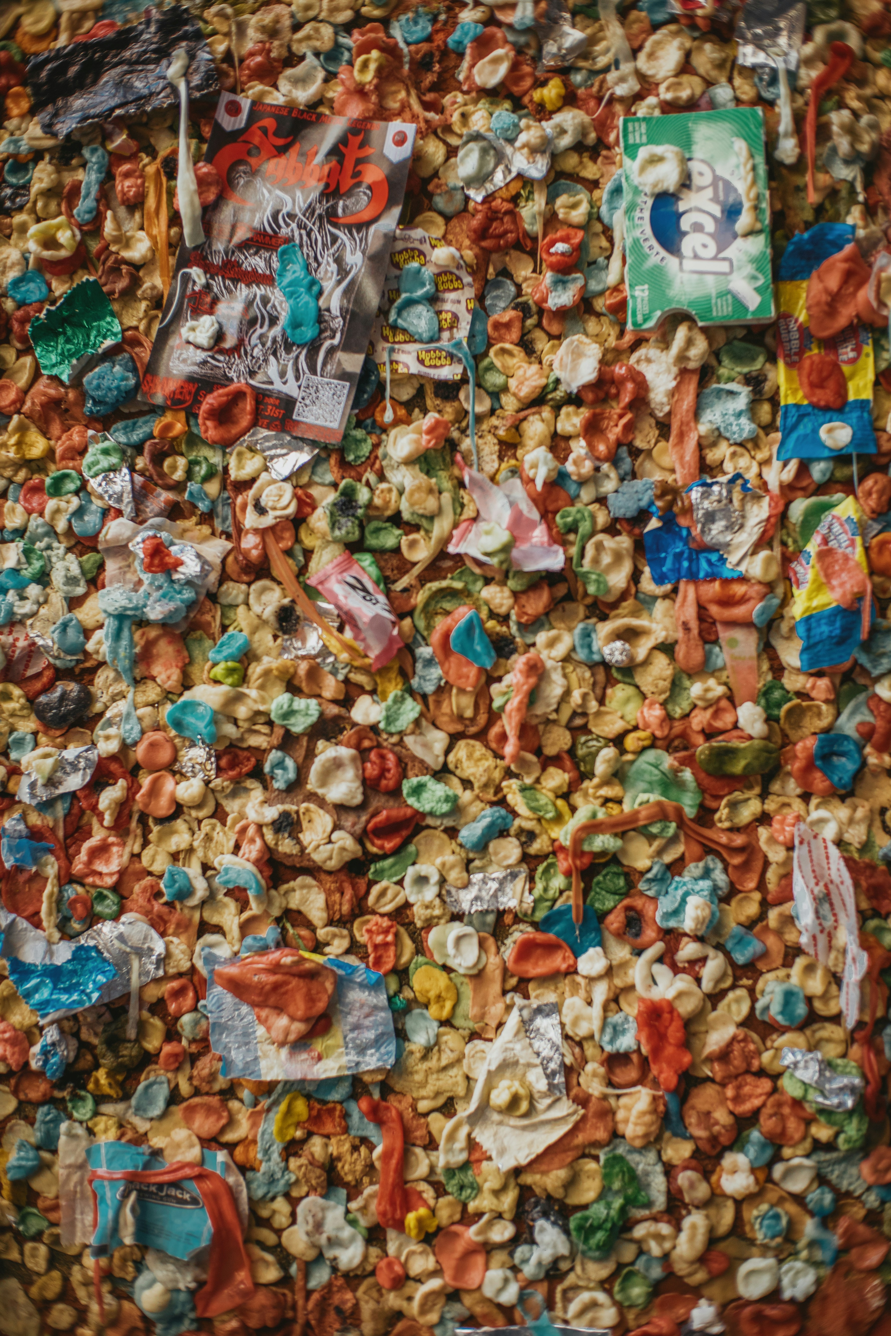 Colorful Pebbles: A Close-Up of Painted Trash Fragments on a Wall