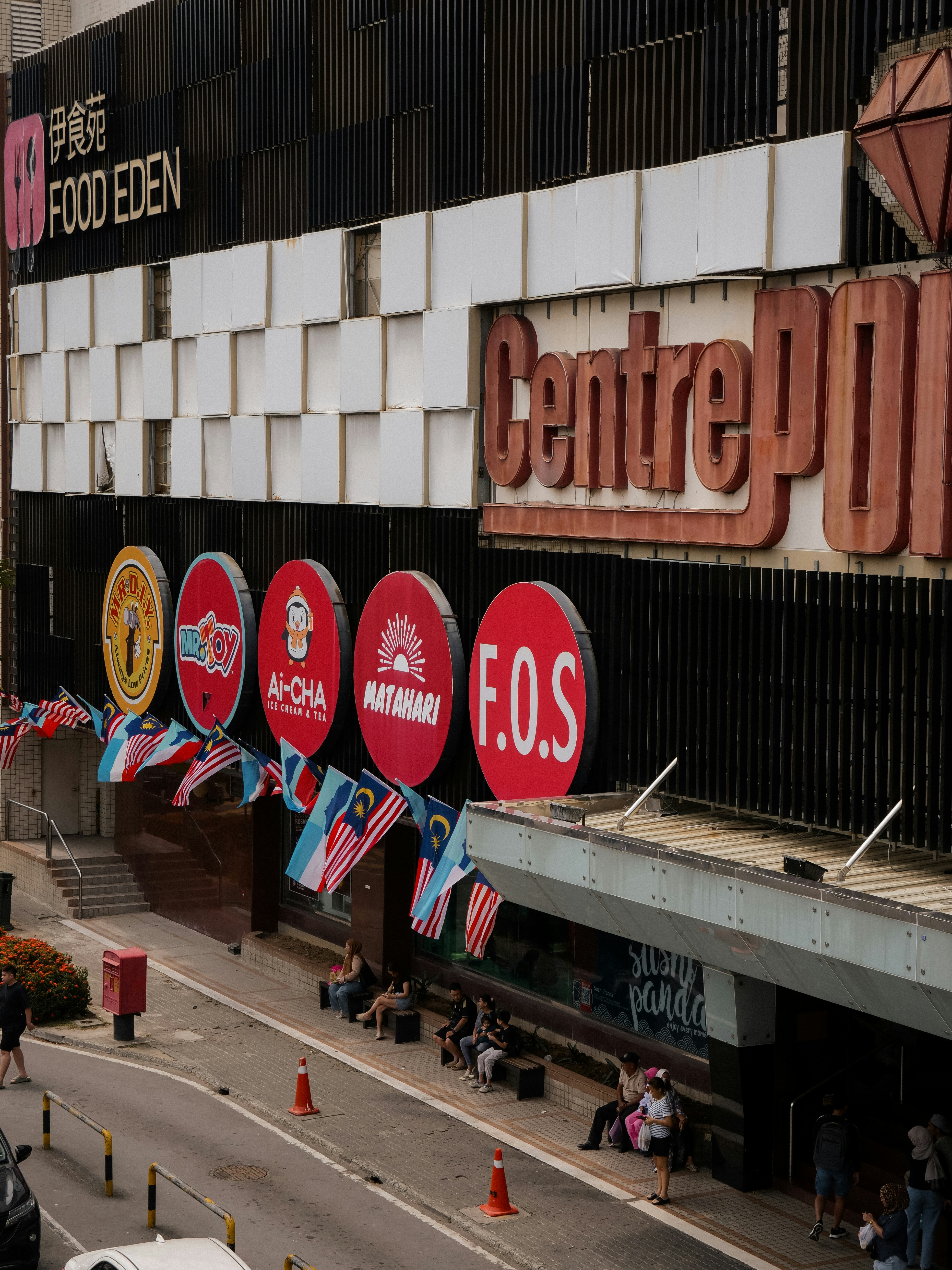 Centre Point of Busy Streets: Food Court Signage and Circular Emblems