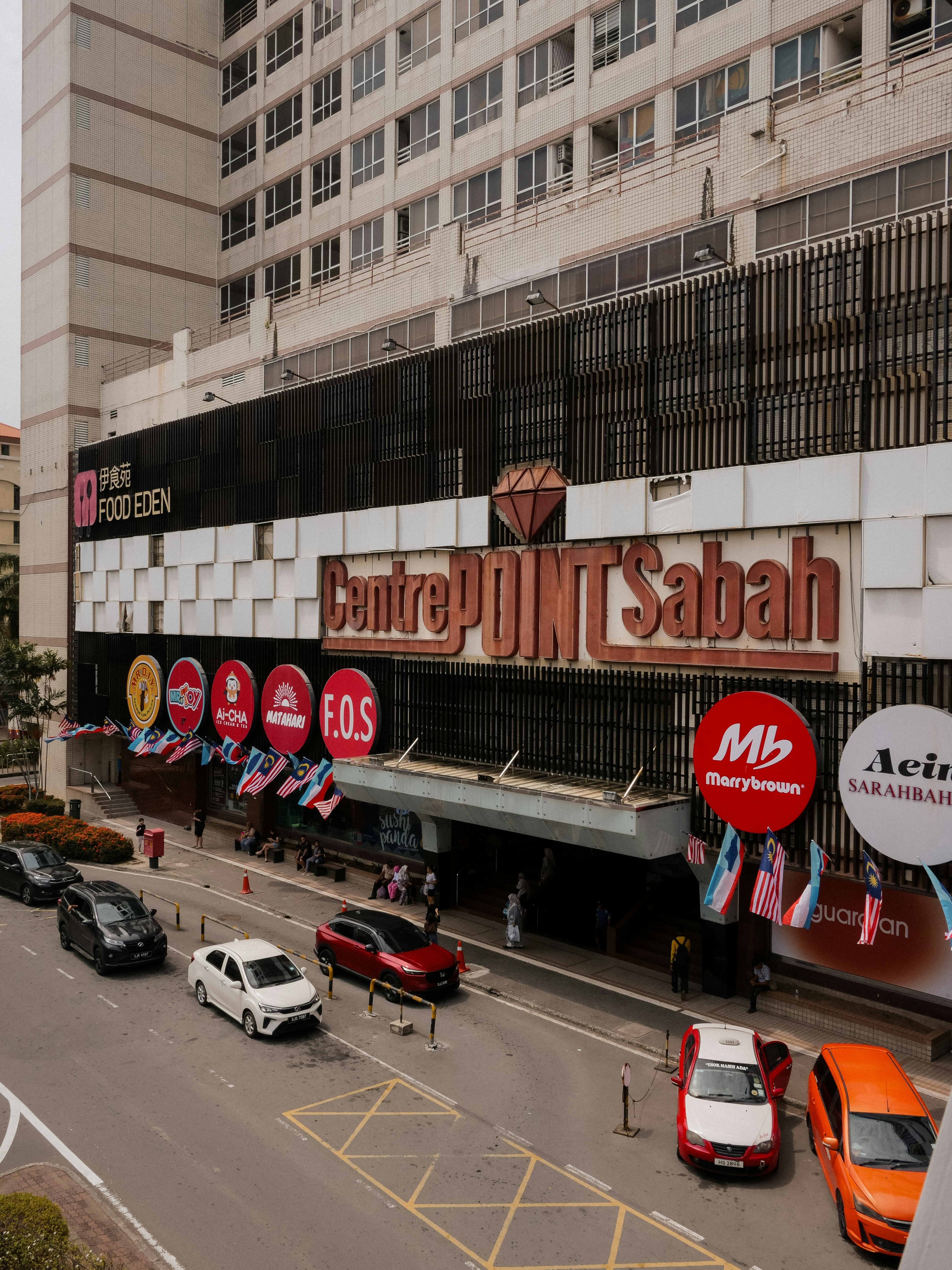 Centre Point Sabah: Street-Level Cabaret of Shops and Cars