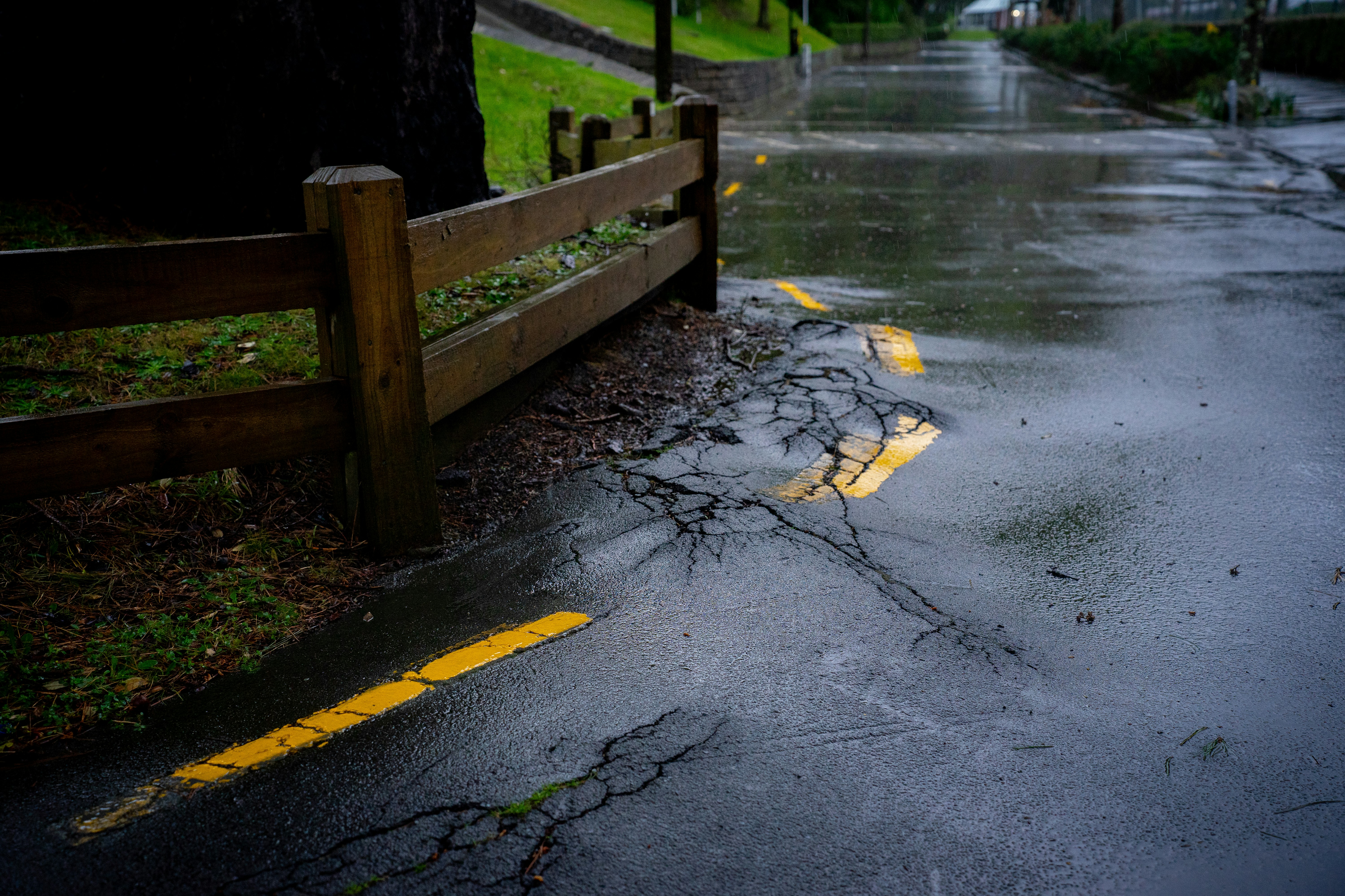 Cracked Road Promenade Under Rainy Overcast