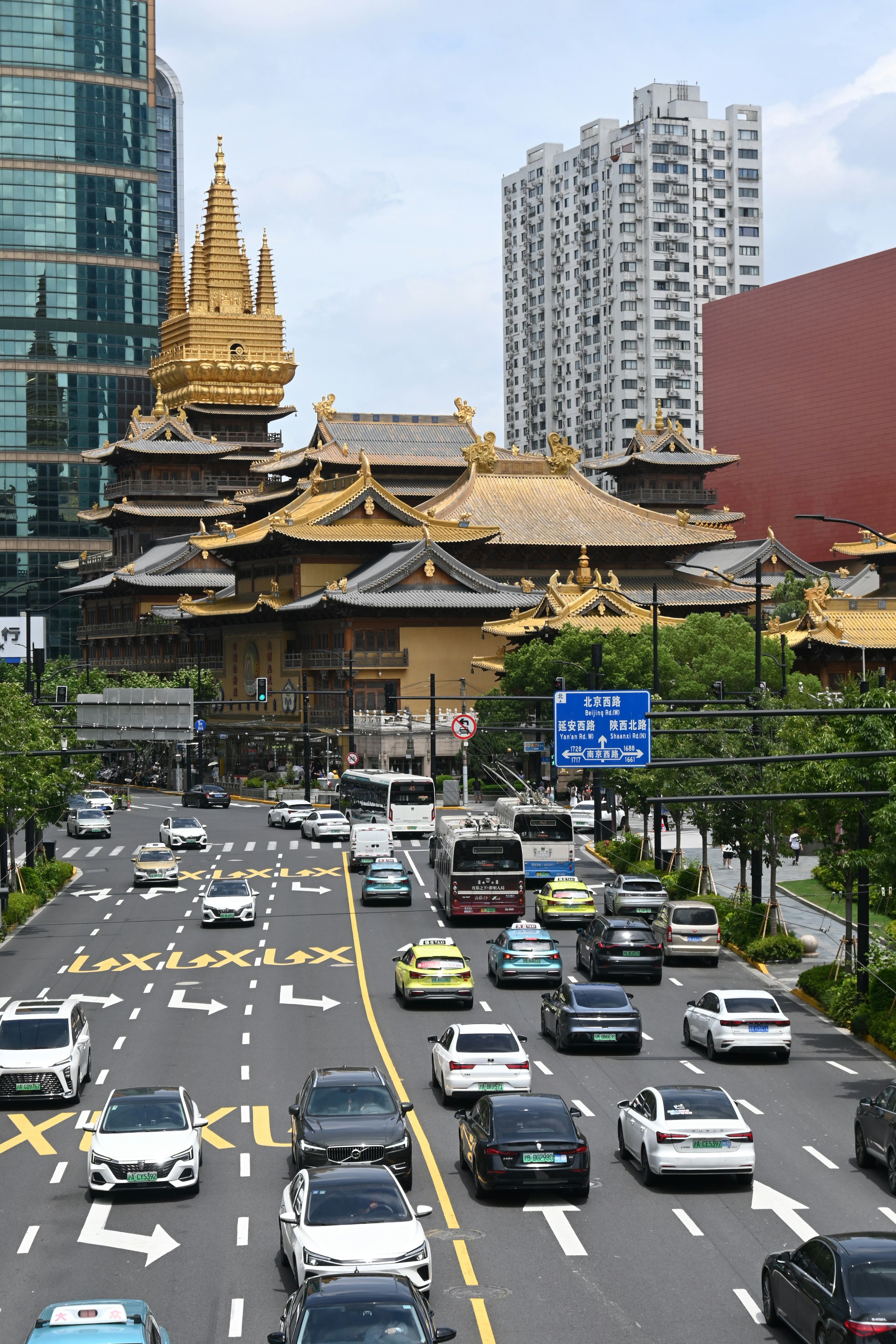 Temple Gate Through the City: Golden Spires Against Urban Sky