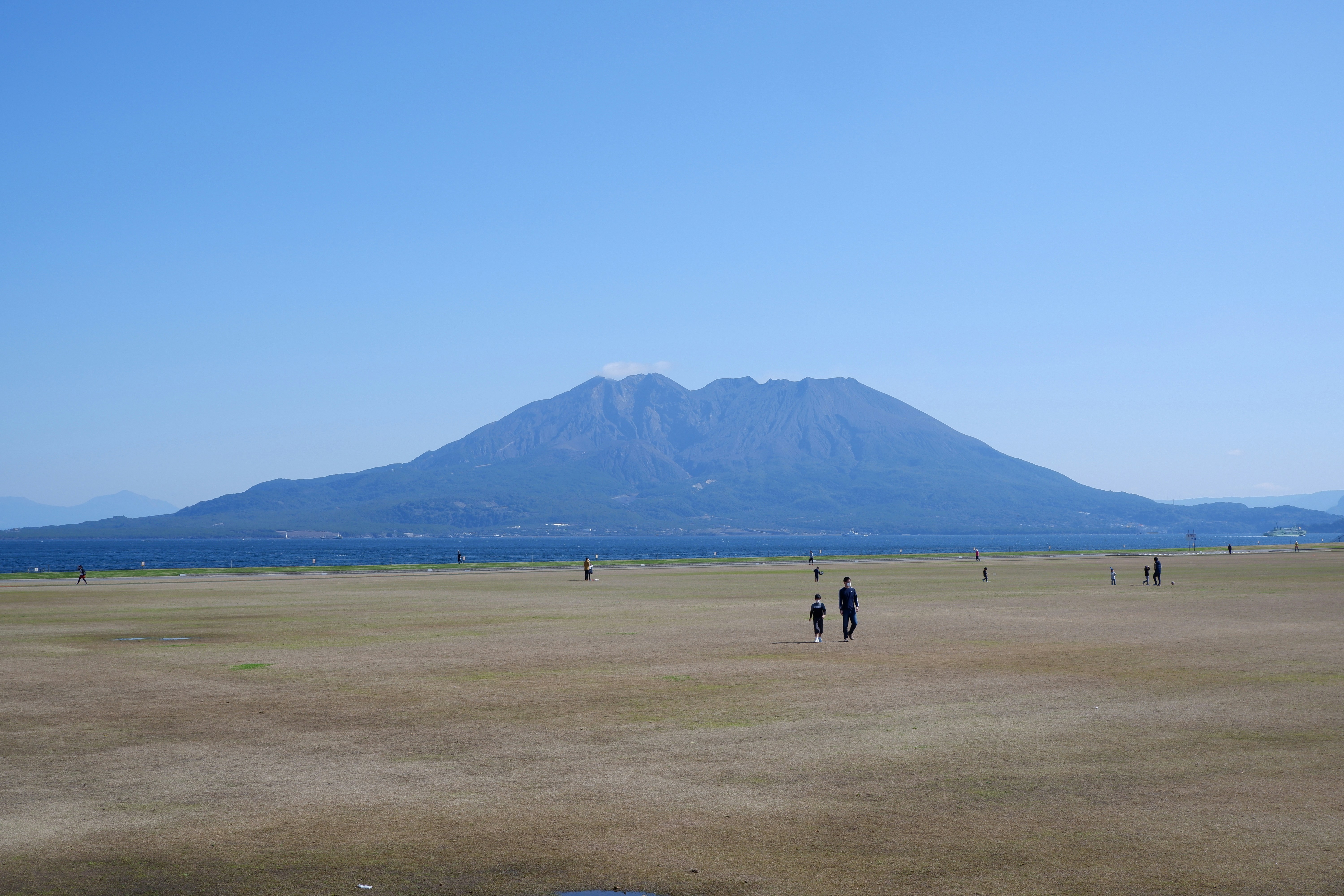 Isolated Summit: A Mountainirised Distant Ridge over a Quiet Tidal Plain