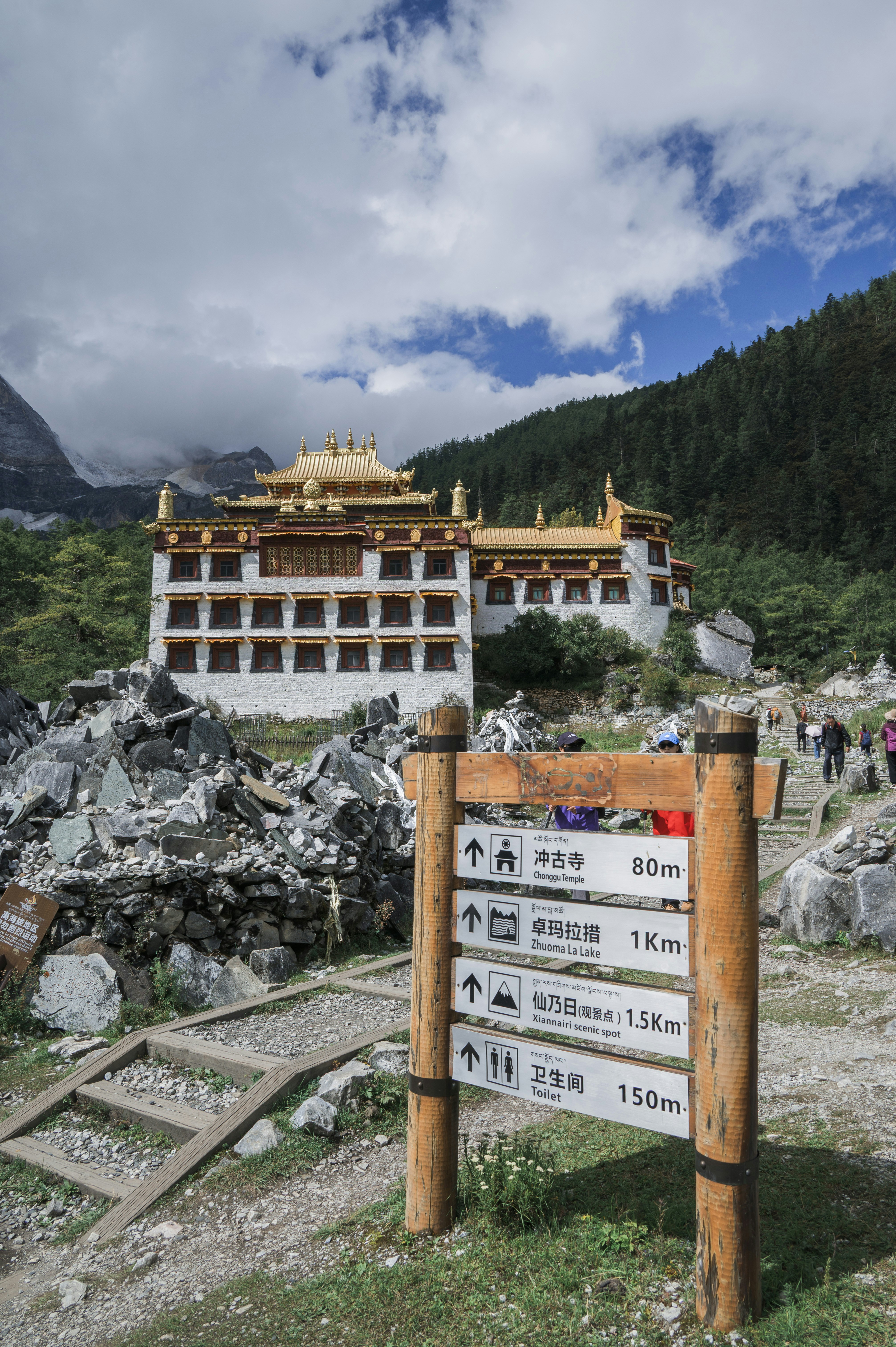 Golden-roofed monastery under a dramatic Himalayan sky