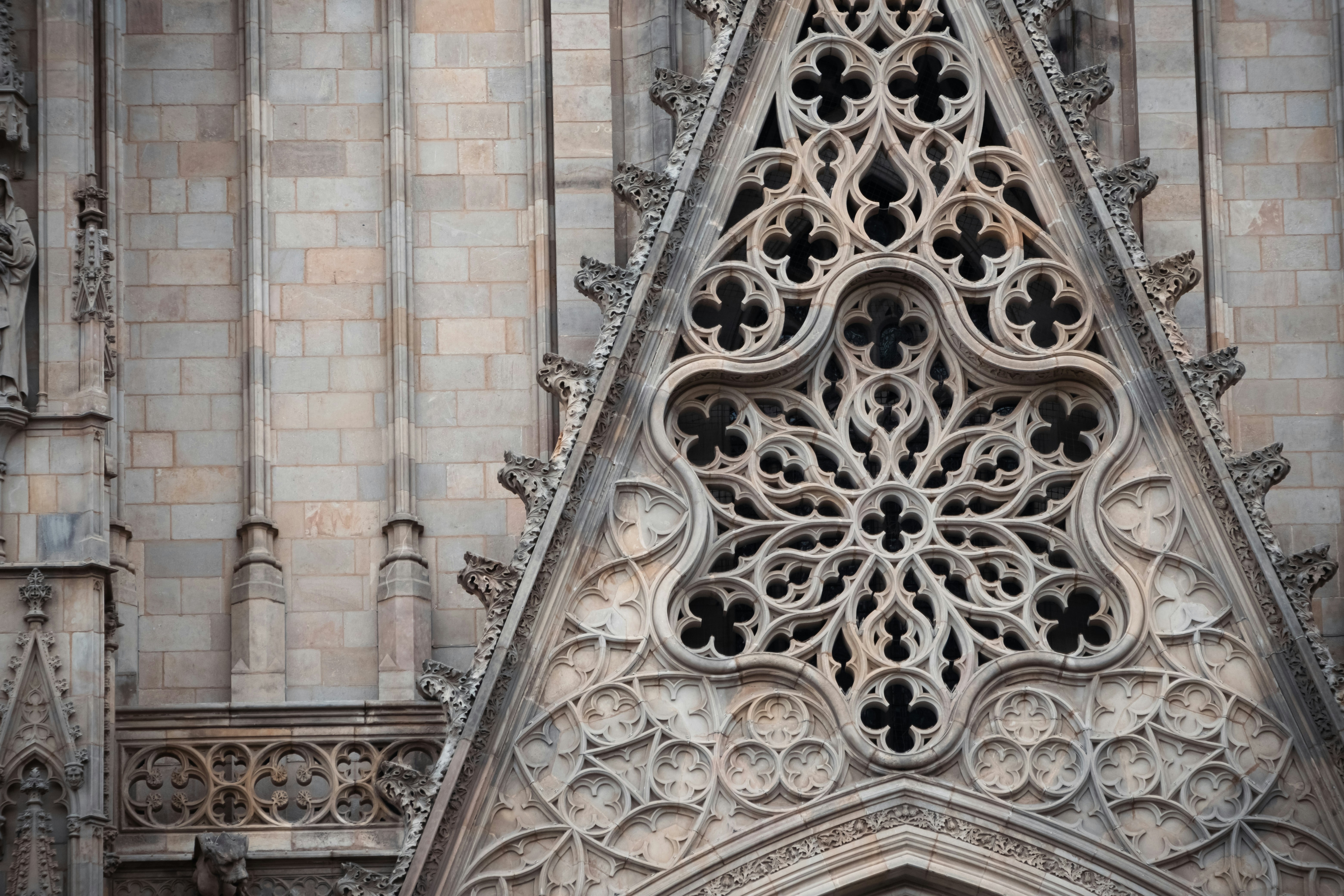 Gothic Facade in Stone: A Close View of Ornate Rose Window Detailing