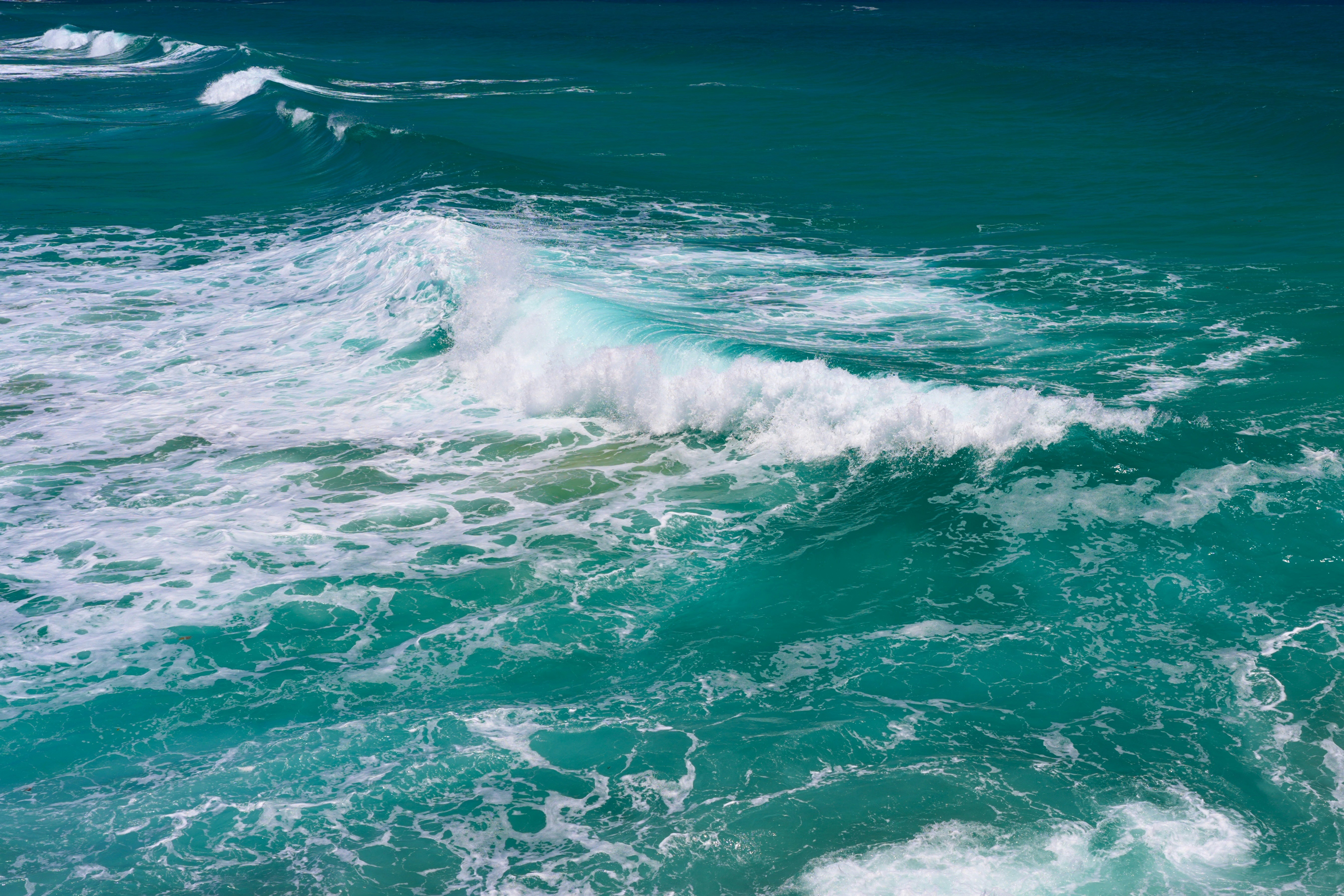 Teal Crest: A Coastal Break Illuminated by Afternoon Light
