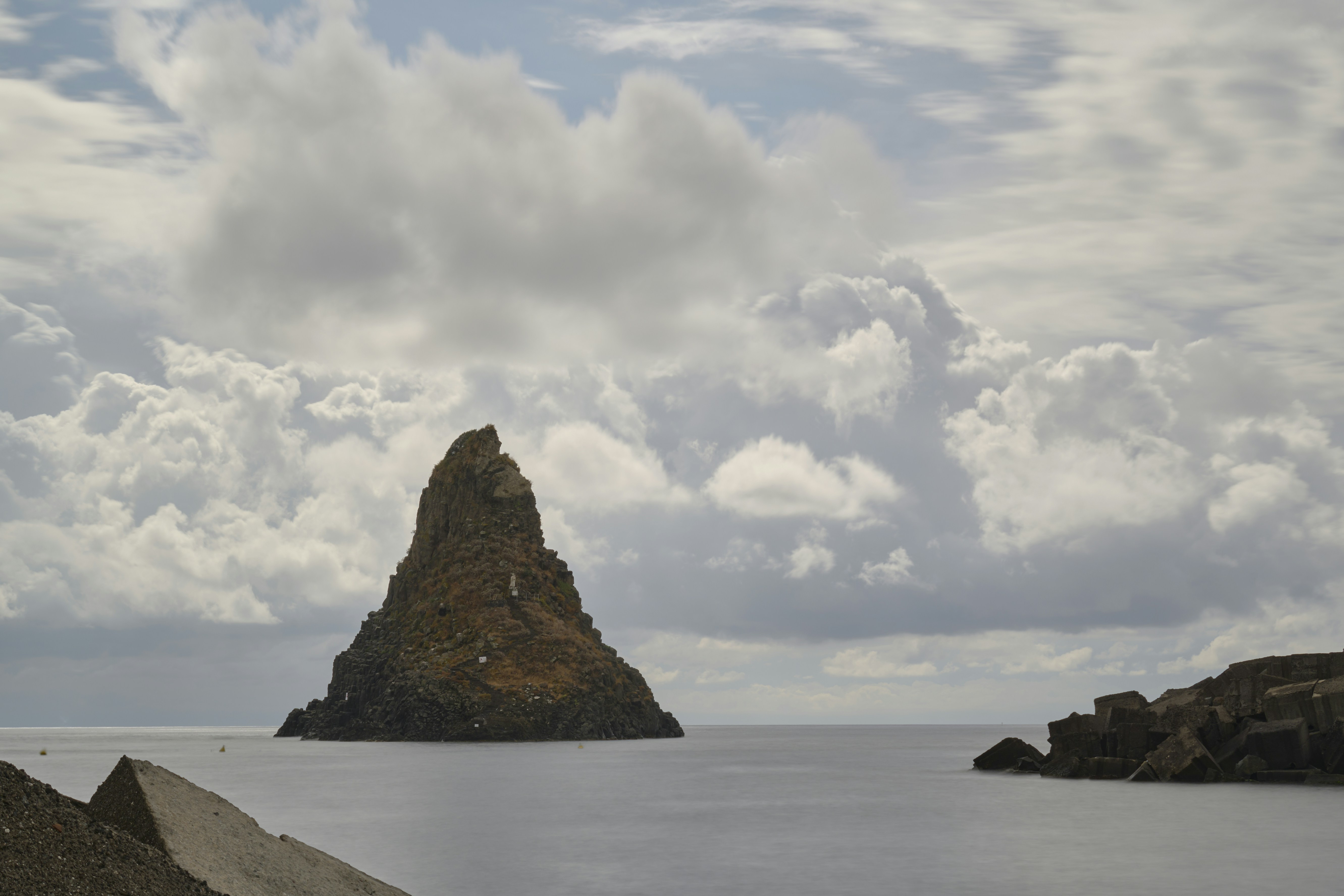 Isolated Pinnacle: A Lone Sea Rock Reaches Toward the Sky