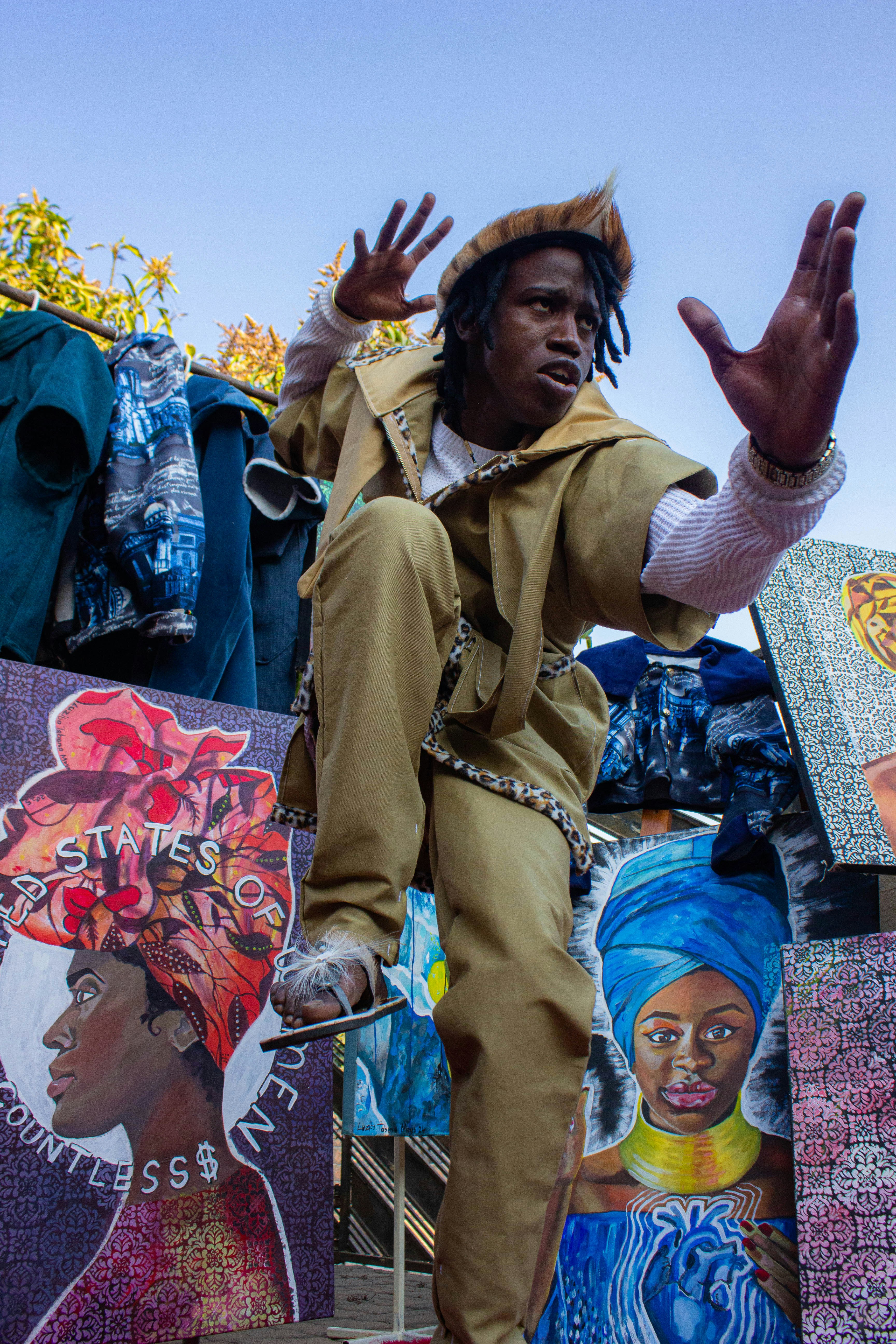 Energetic Street Pose Surrounded by Painted Portraits