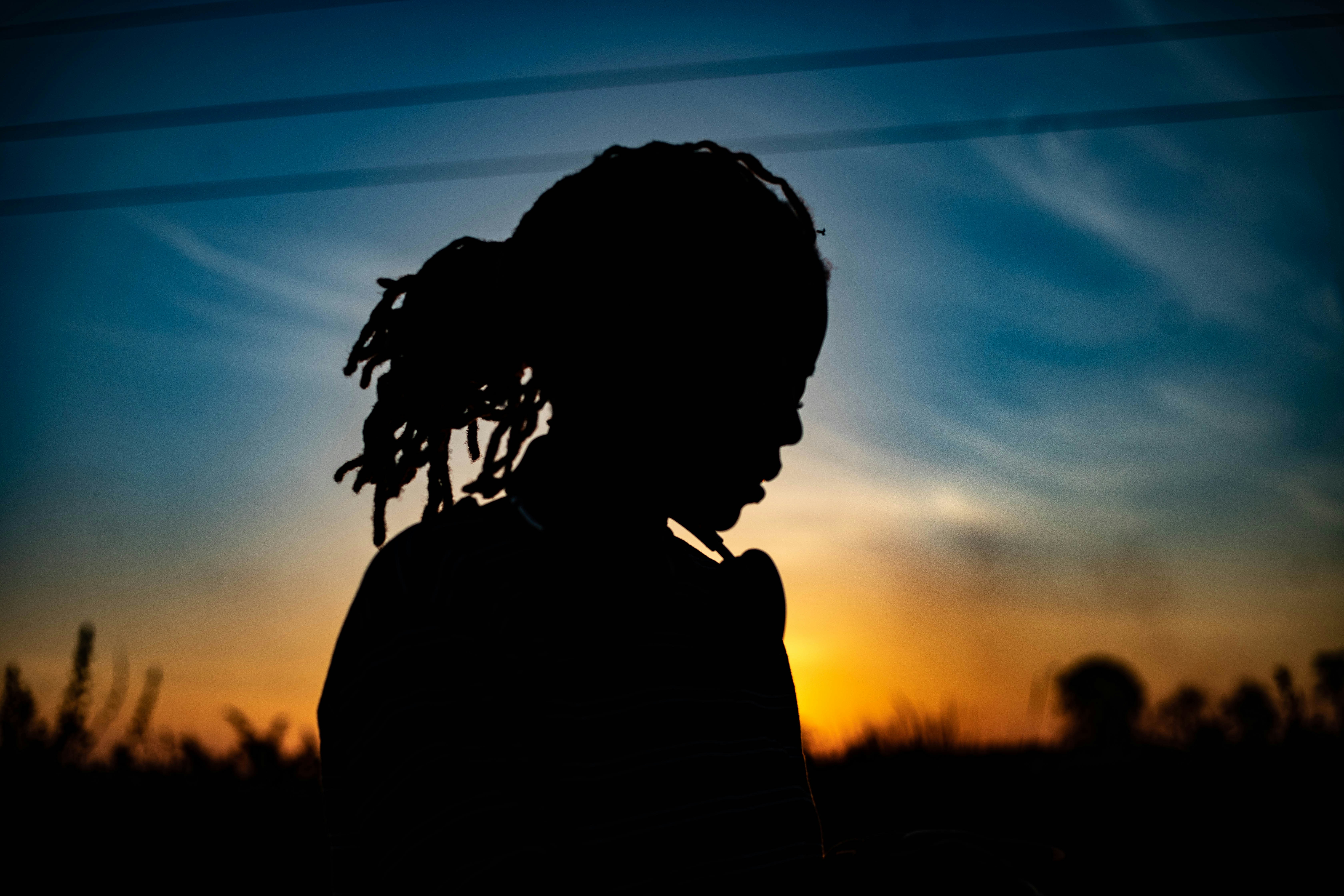 Silhouette at Sunset: A Quiet Portrait Against a Dusk Sky