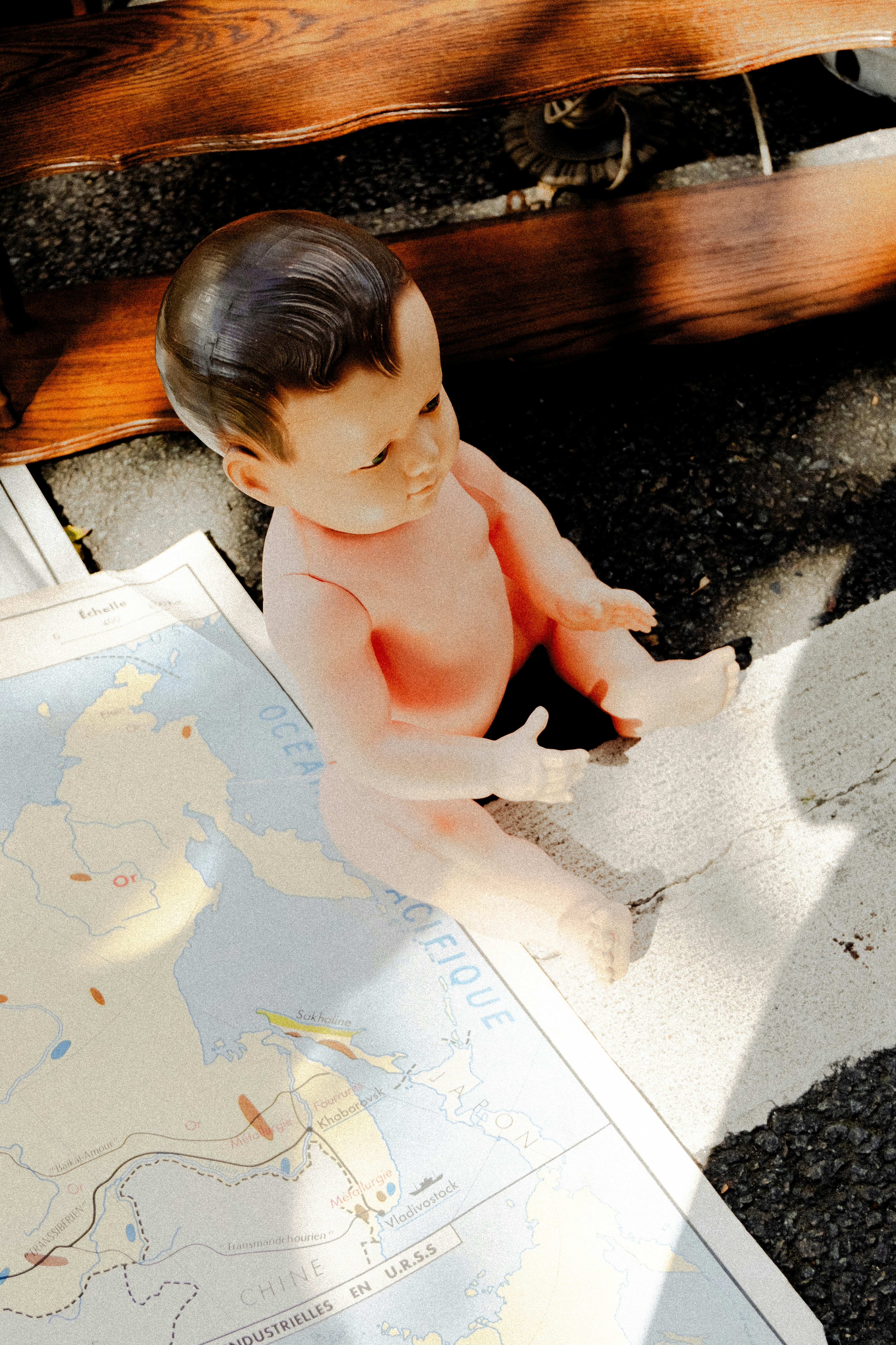 Plastic Portraits: A Childlike Explorer Studying a World Map