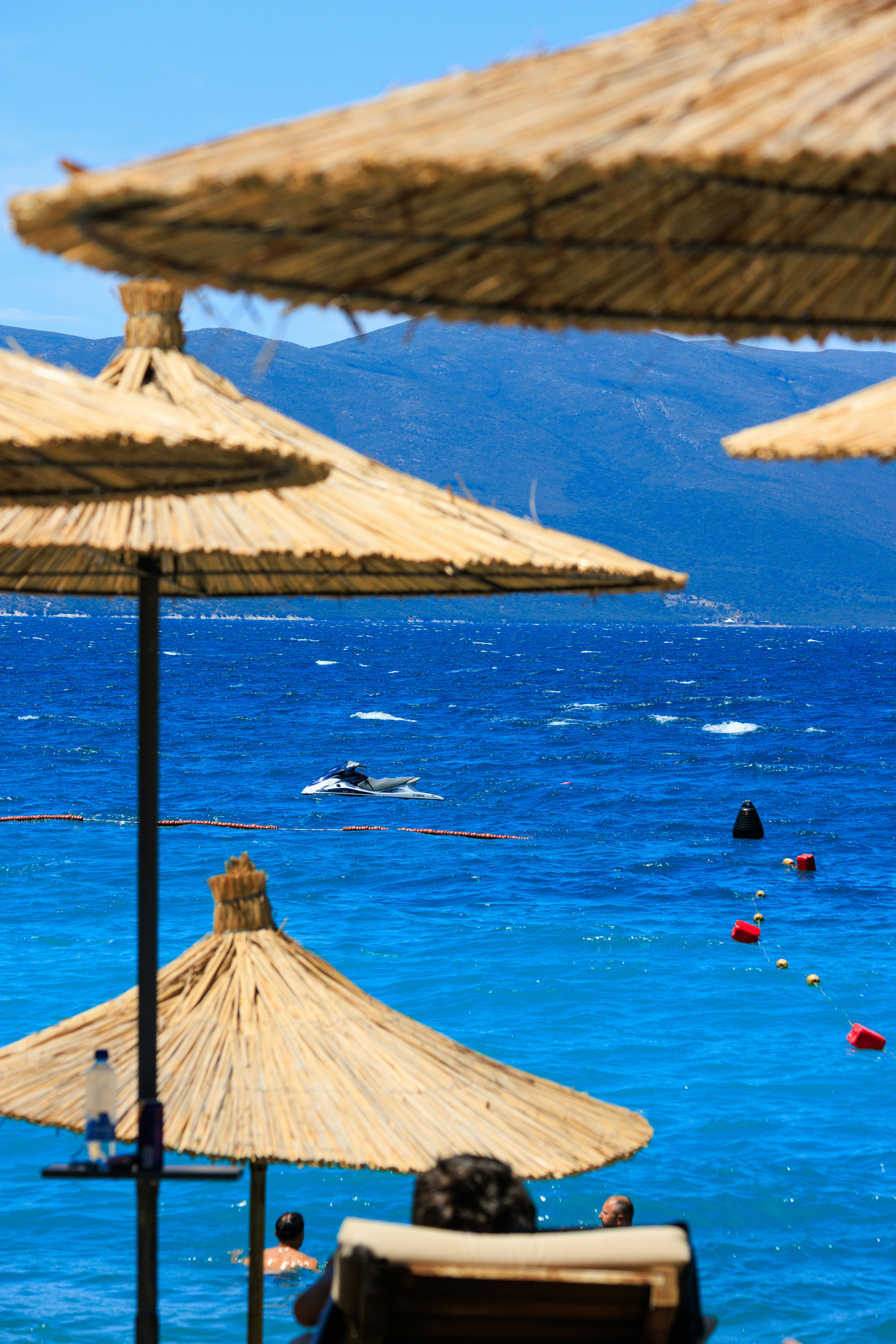 Blue Grotto Moments: Umbrella Shadows and Sea Intrigue
