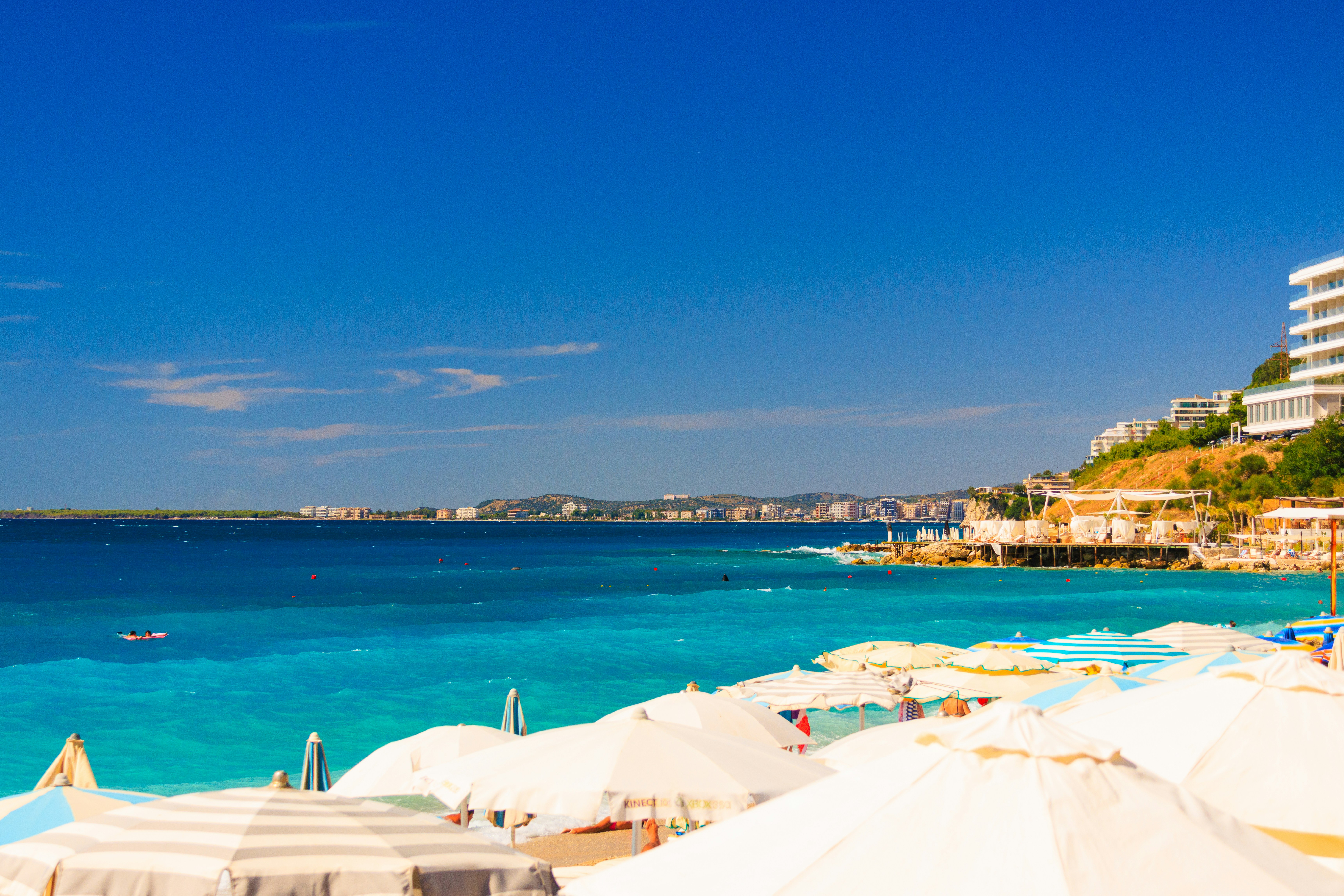 Azure Horizon Beneath a Coastal Parade of Shade and Umbrellas