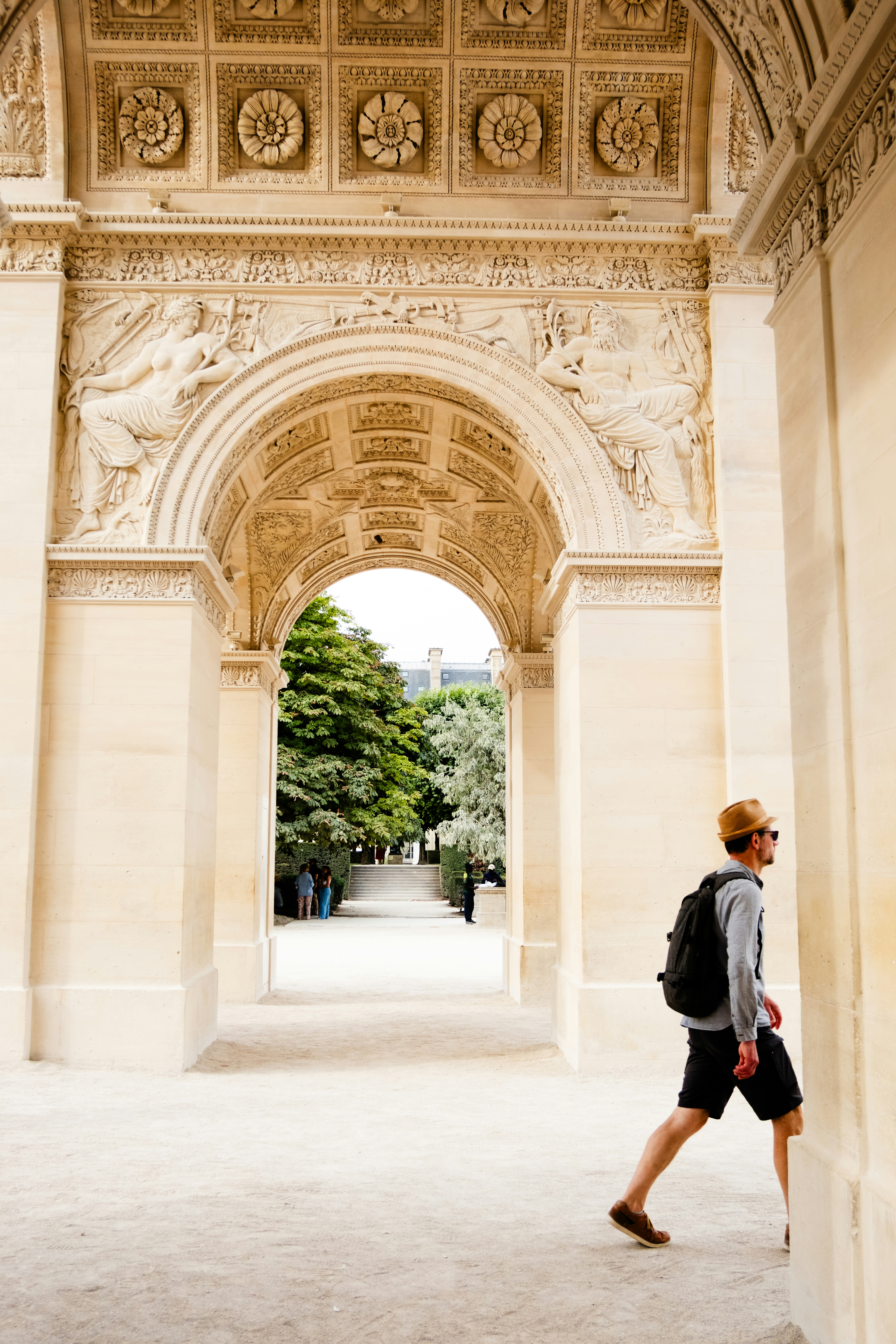 Arched Passageway Framing a Wandering Traveler