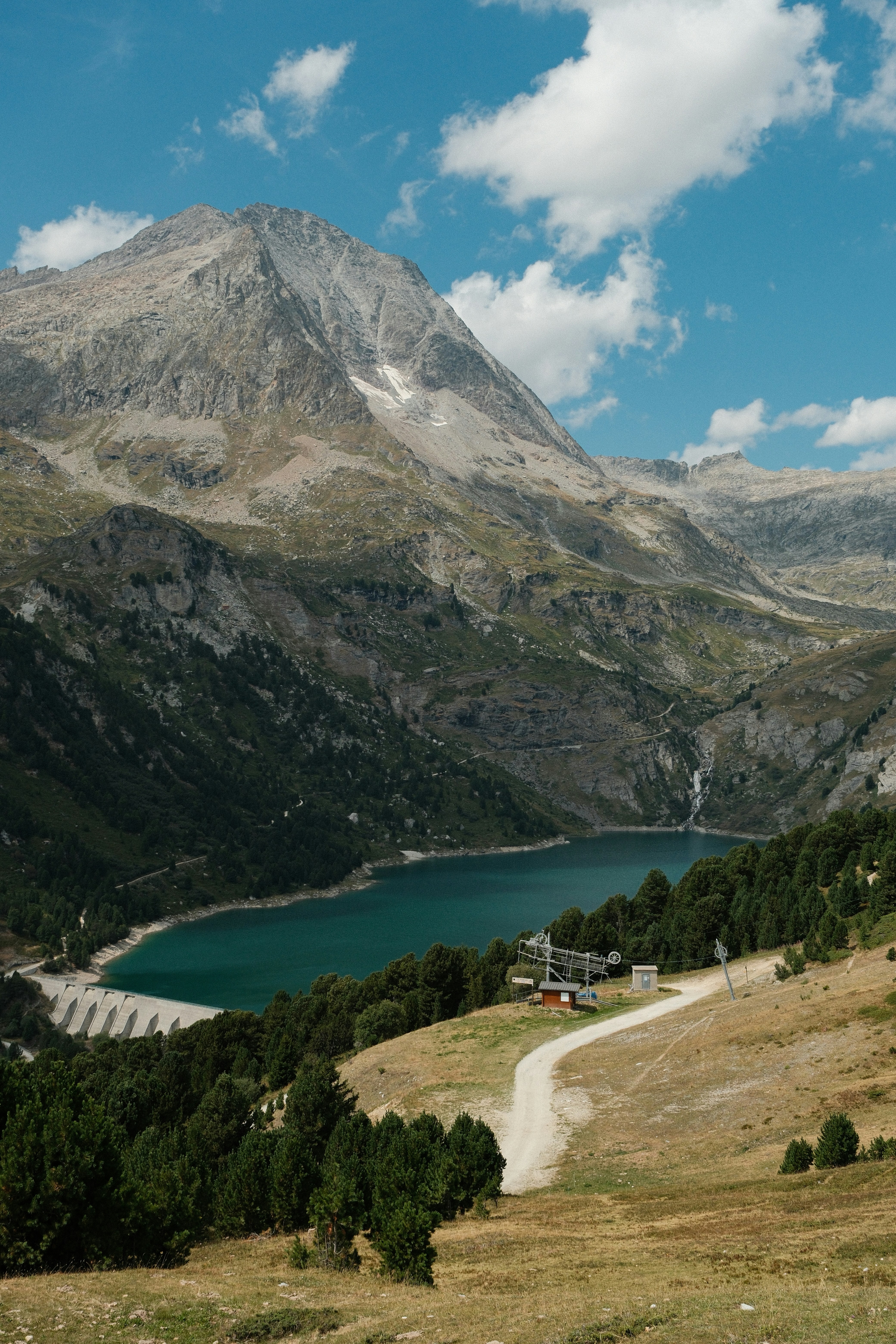 Lakeside Path Bends Toward a Mountain Ringed with Pines