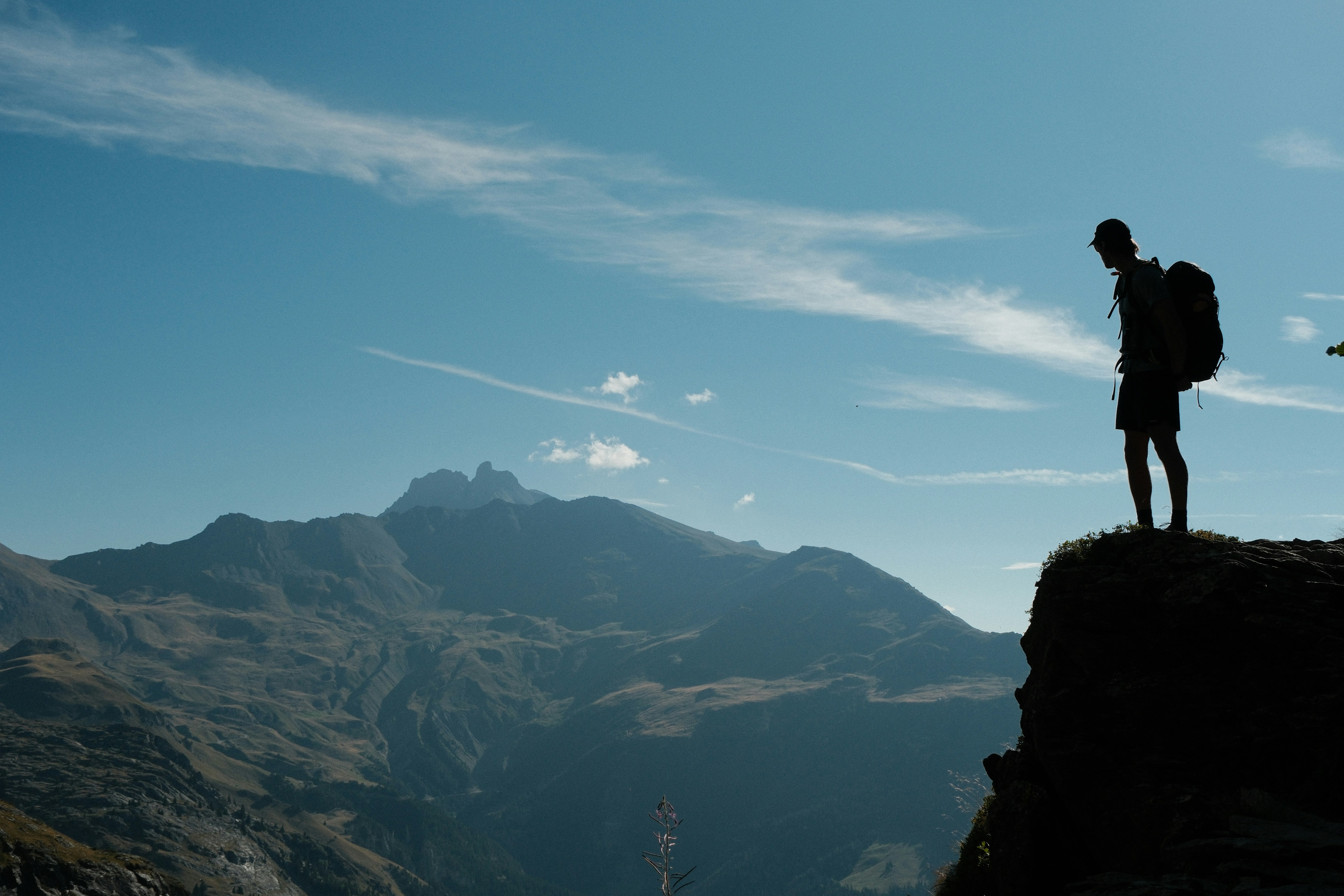 Ridgewalker at the Edge: A silhouette against the alpine expanse