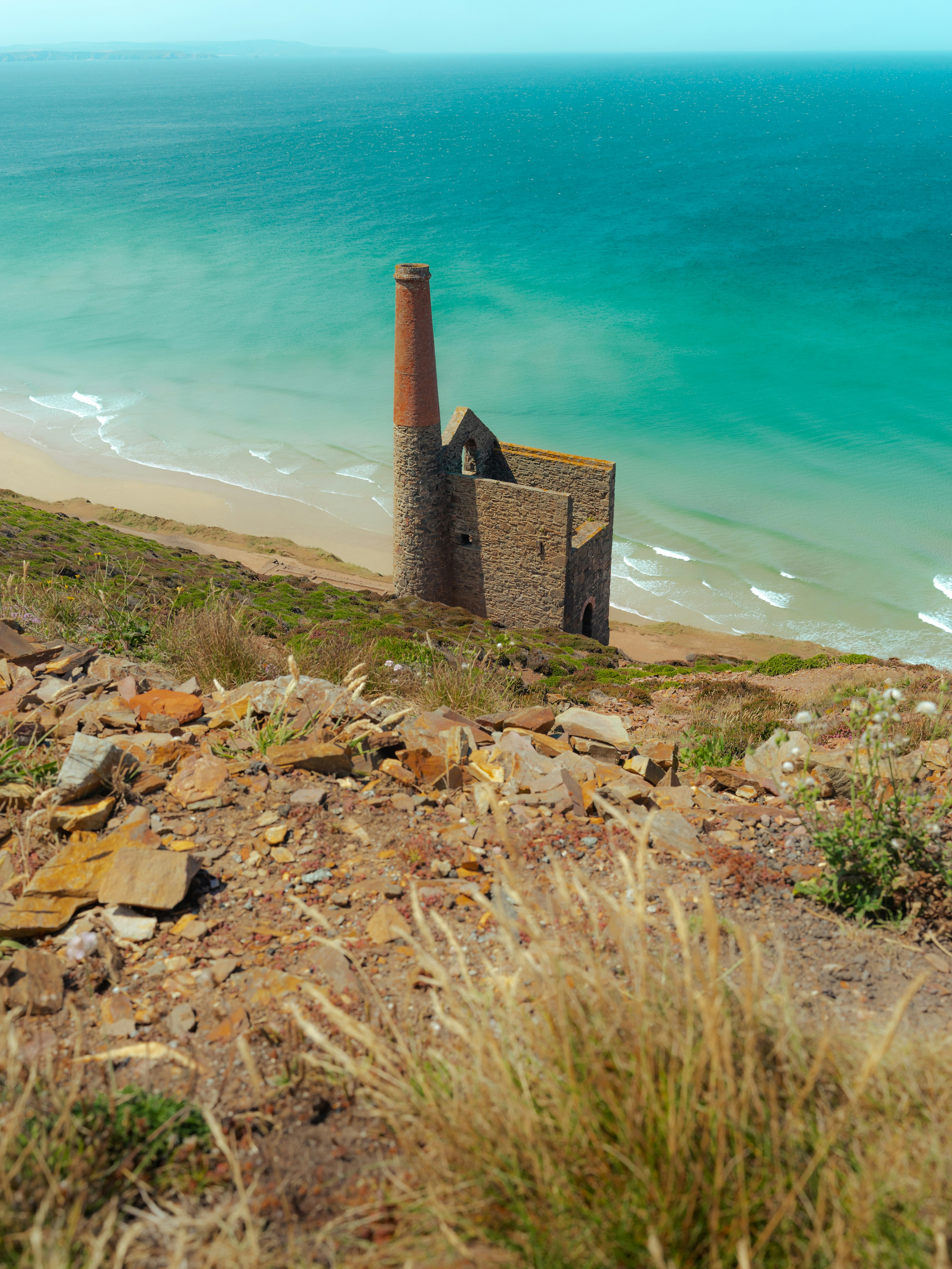 Coastal ruin standing guard above turquoise tides