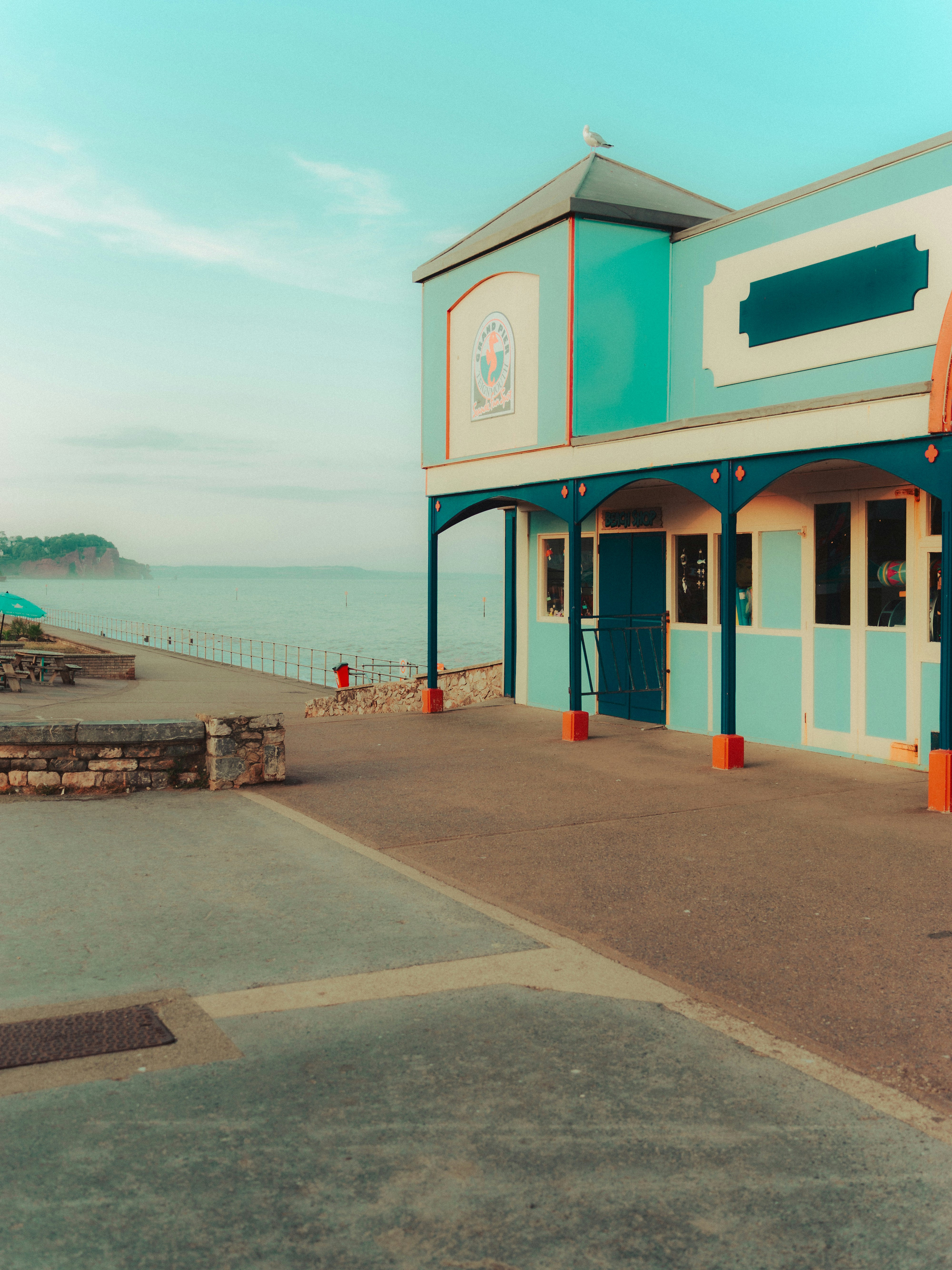 Coastal Arcade: Teal Facade by the Pier