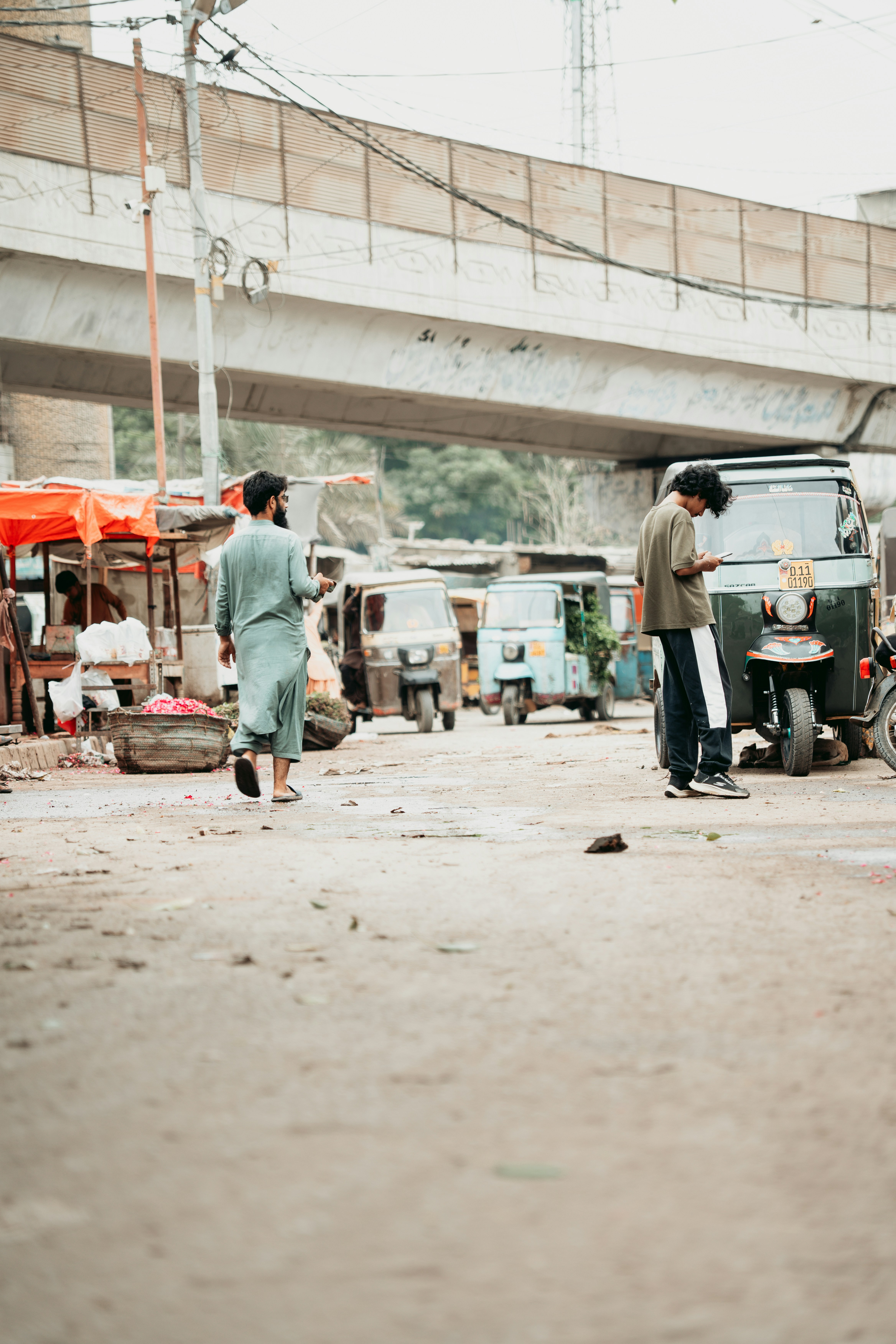 Under the Overpass: Street Life with Grays and Blues