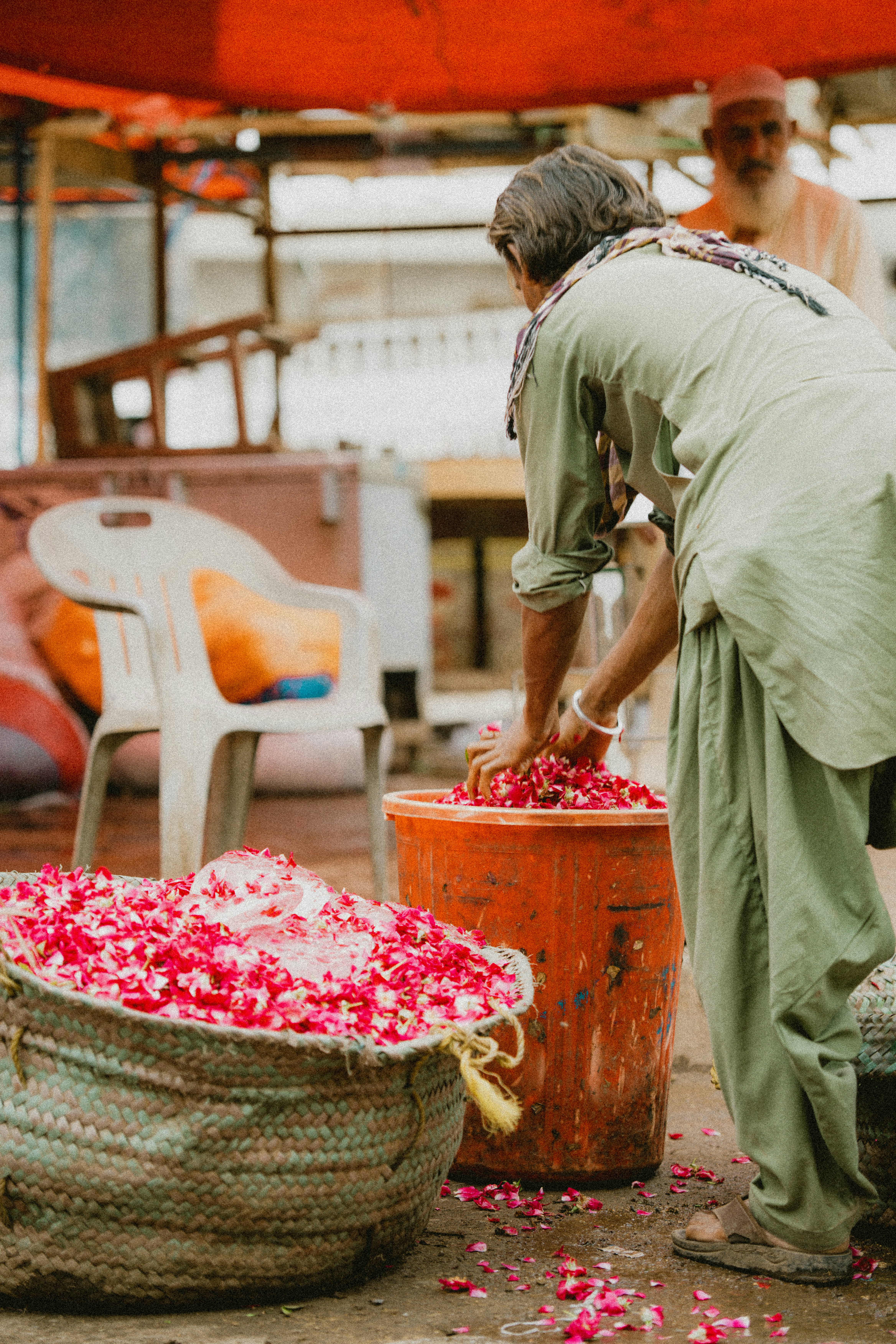 Hands in Bloom: A Market Vendor Tends to Petals