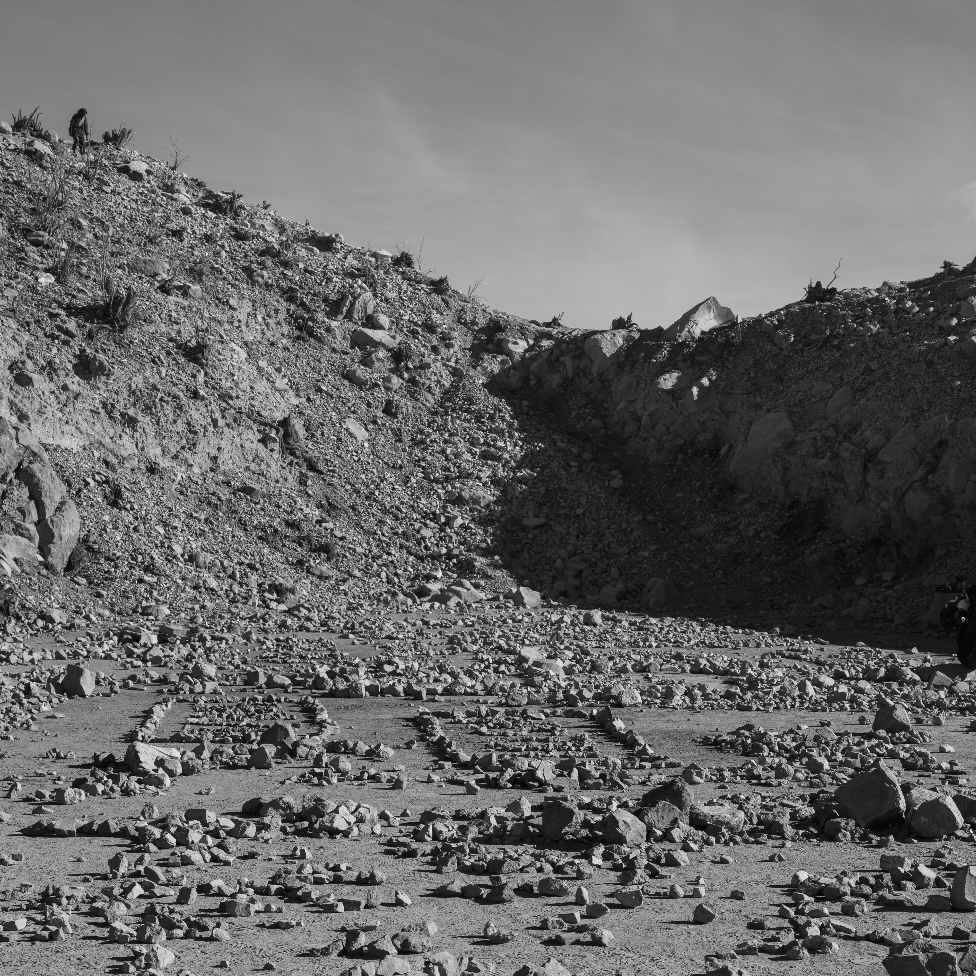 Rocks around the summit crater of Mount Sindoro. Words can be seen arranged using stones. Captured in August 2026.
