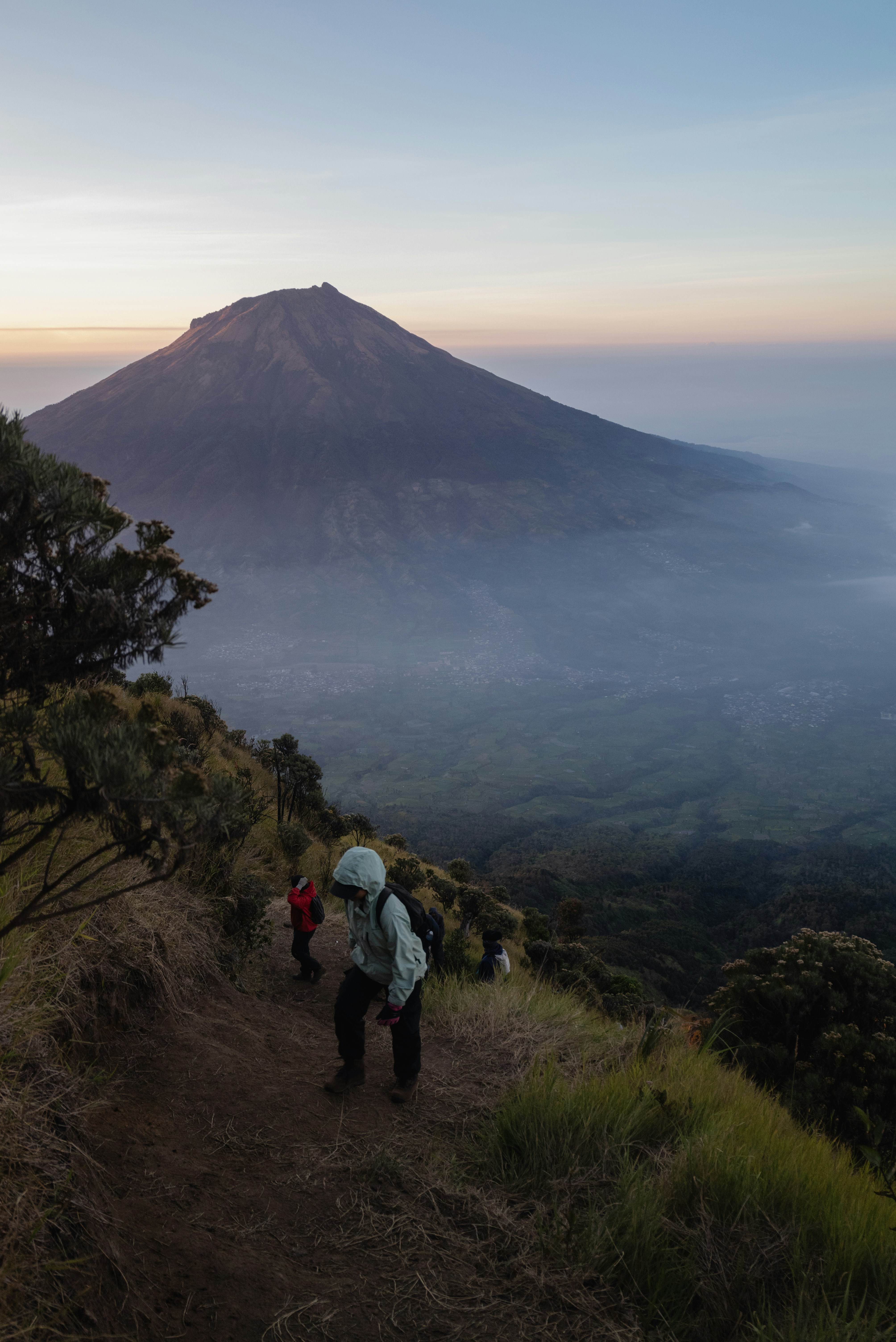 A Trekker's Ascent Beneath A Peak at Dawn