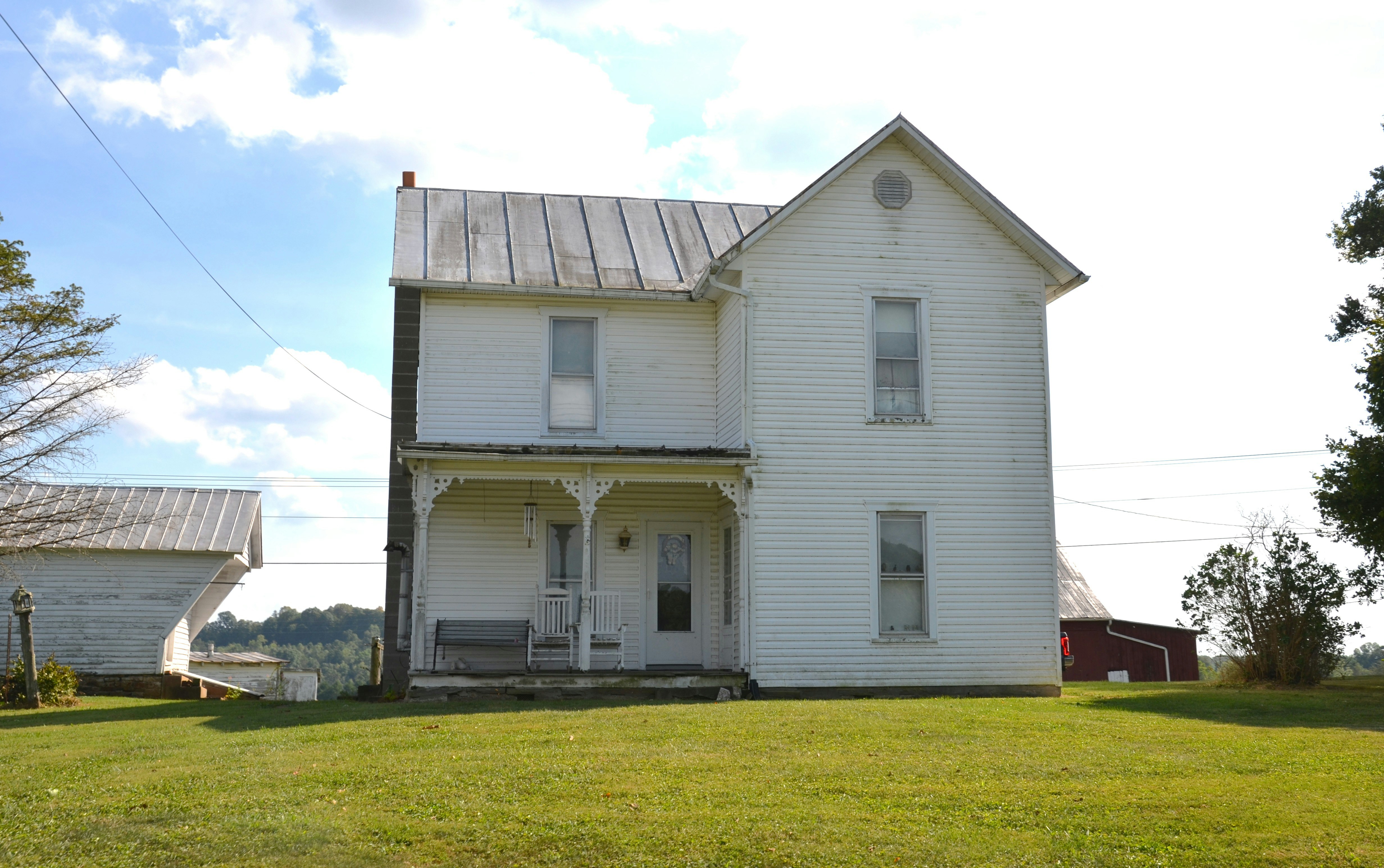 A Weathered Farmhouse Stands Guard Over a Quiet Lawn