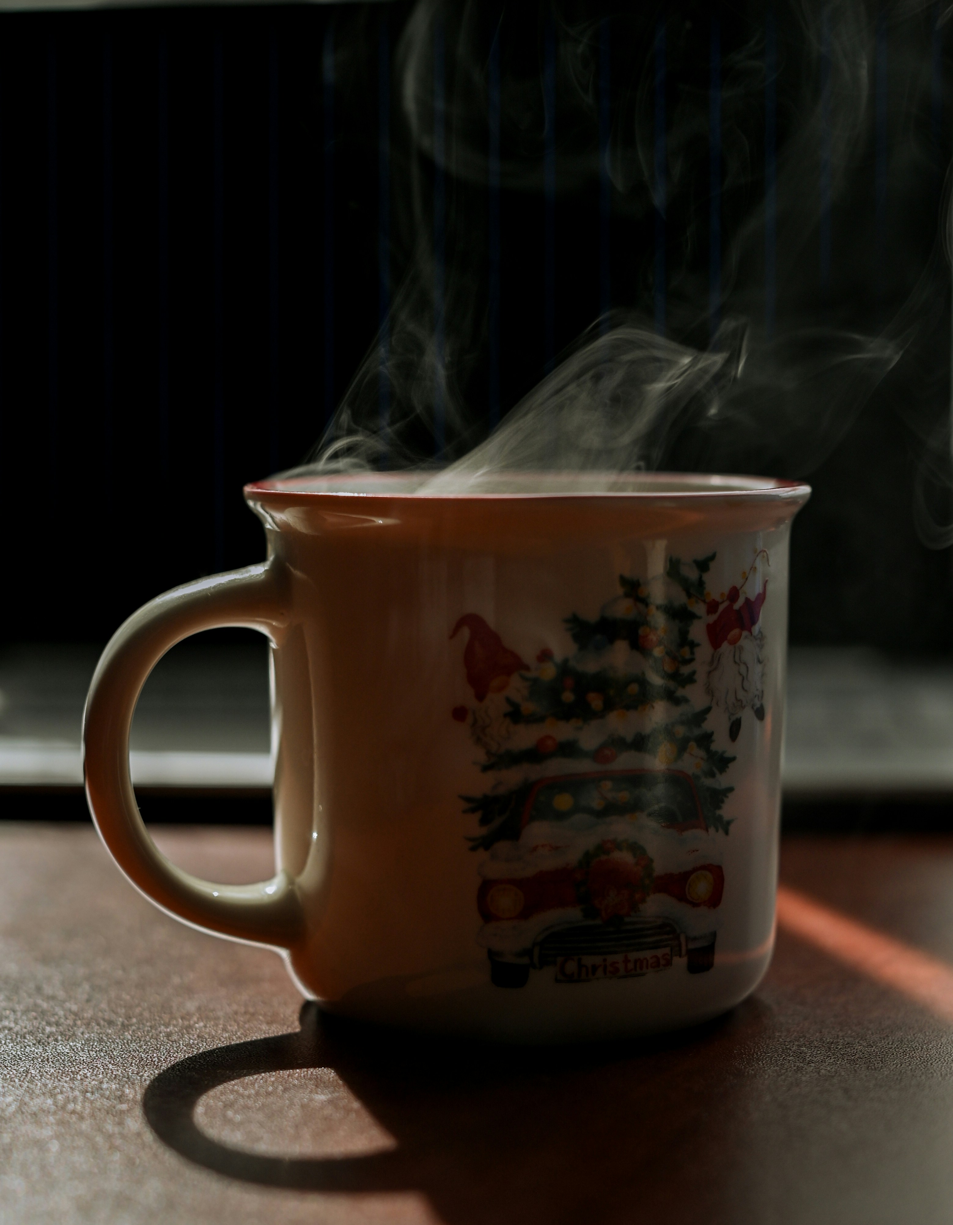 Steam Rising from a Christmas Mug: Warmth and Quiet in a Dark Kitchen