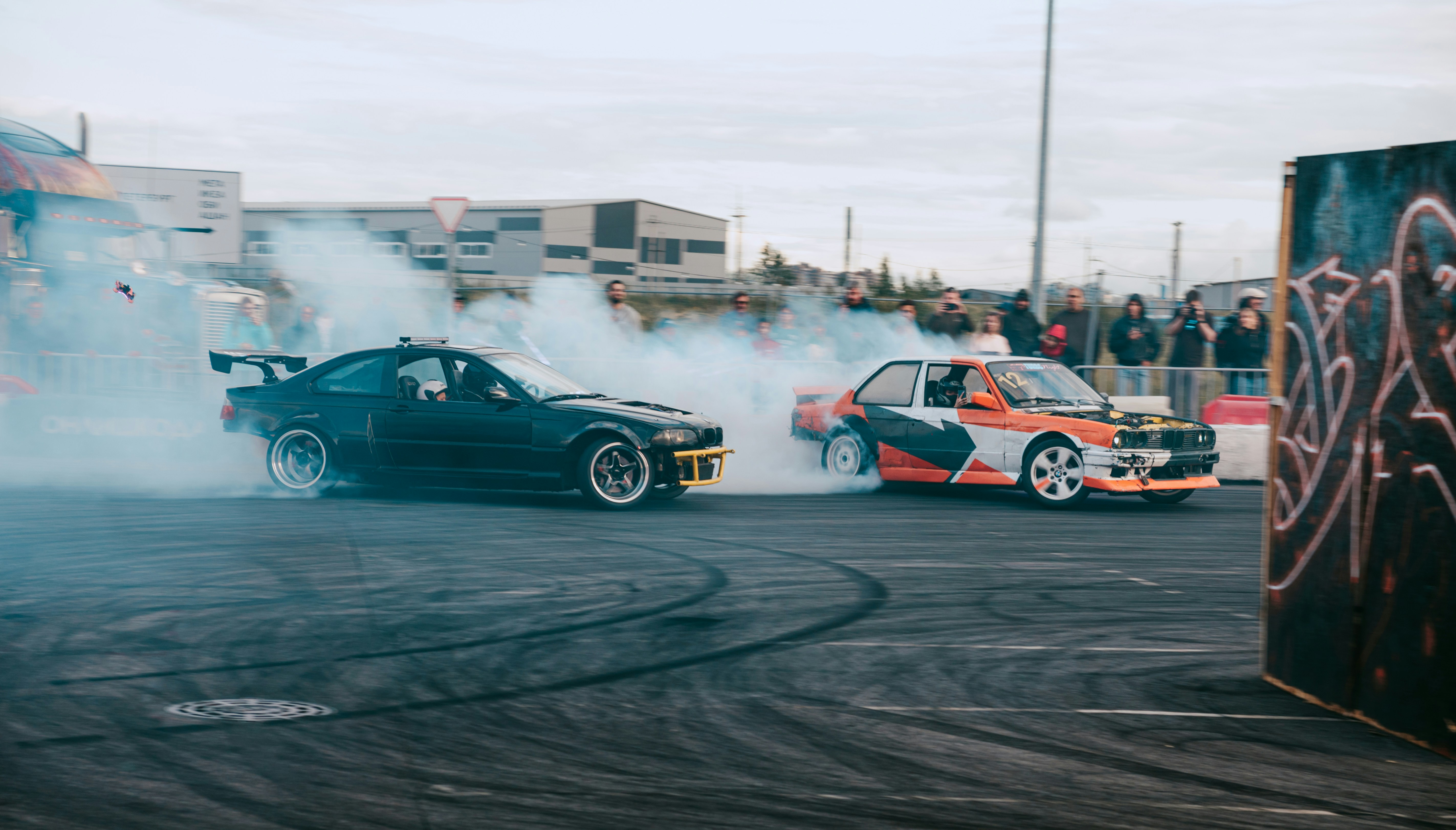 Two Drift Machines Duel in a Smoke-filled Open Lot