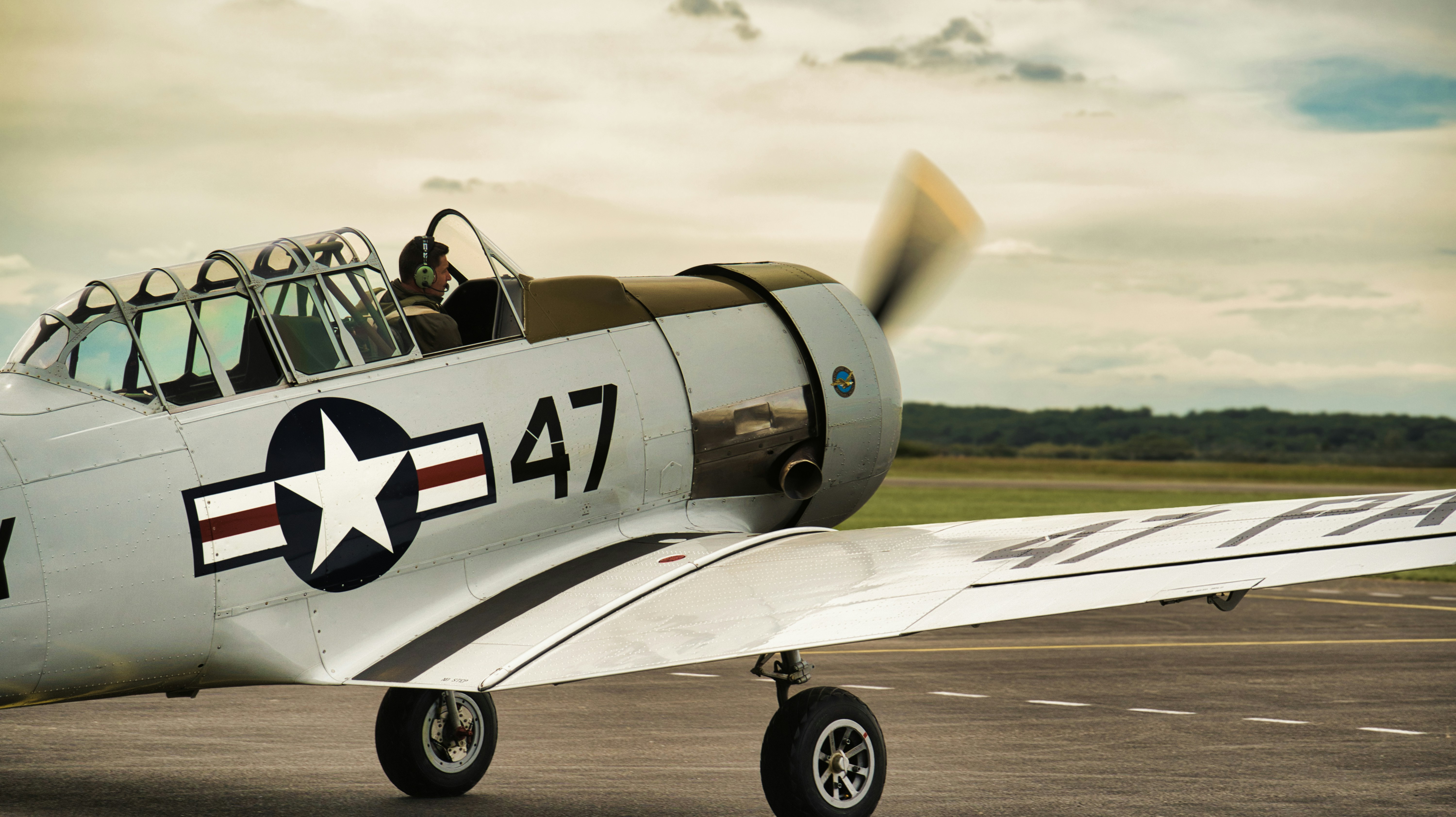 Tail-Wheel Tell: Classic Warbird at Idle on a Sunlit Tarmac